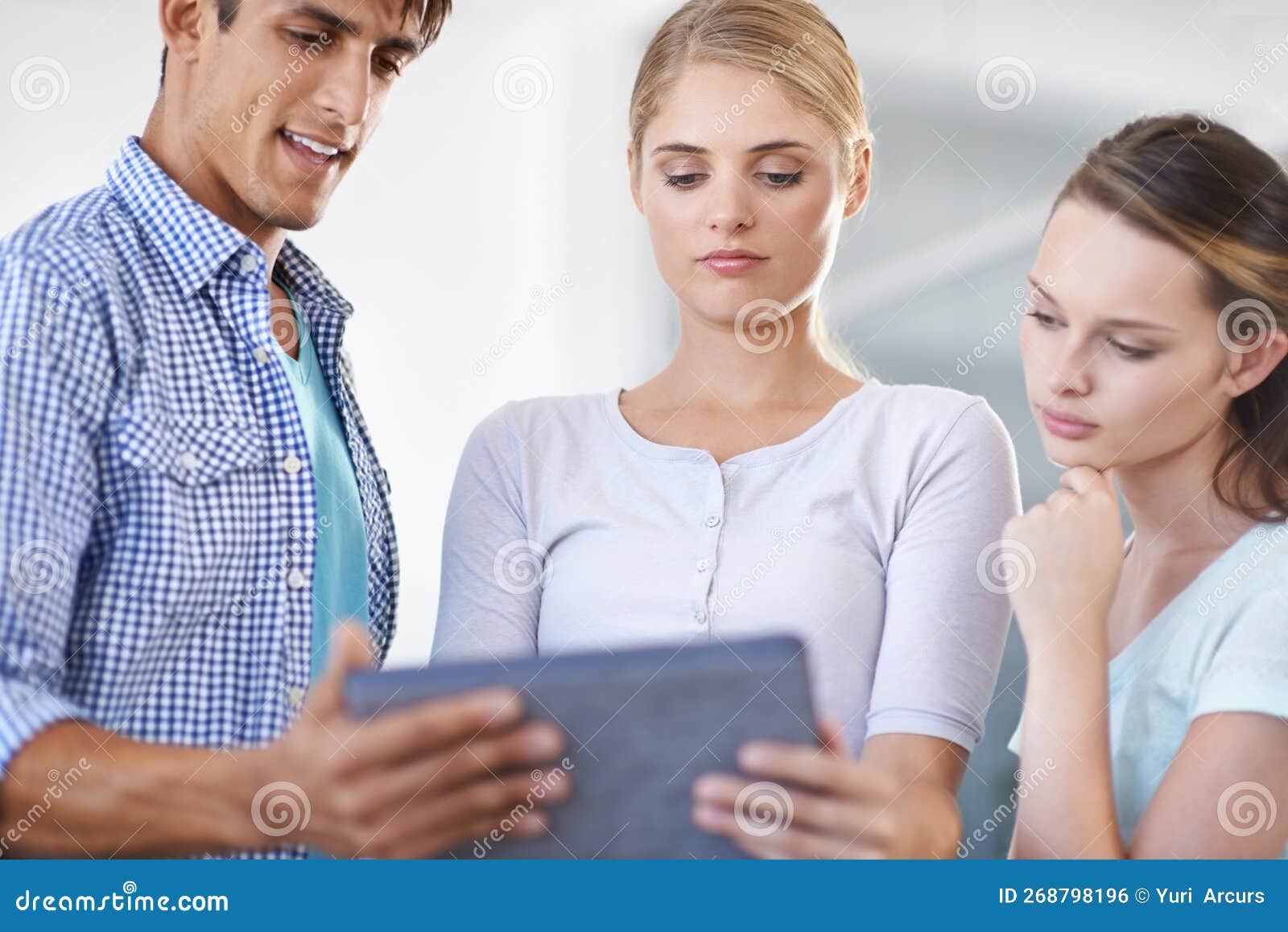 Sharing Technology. a Group of Young Creatives Looking at a Digital ...