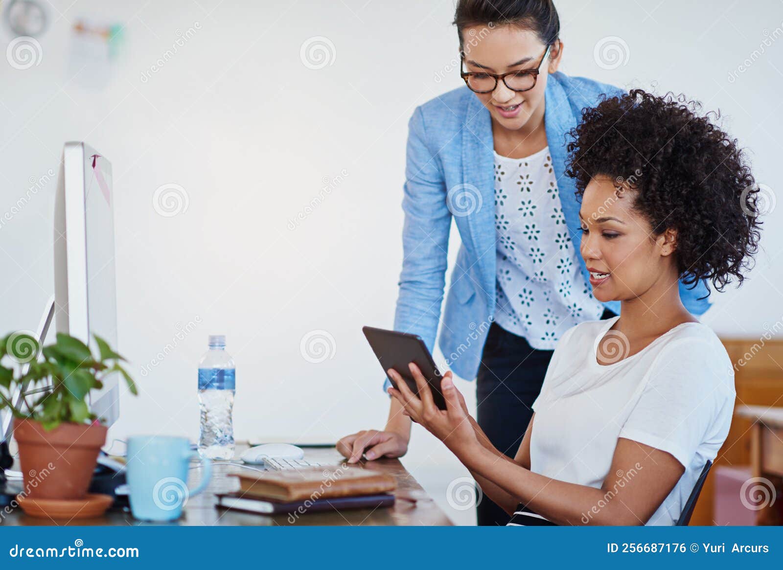 Sharing Technology and Ideas. Two Young Designers Talking Together Over ...