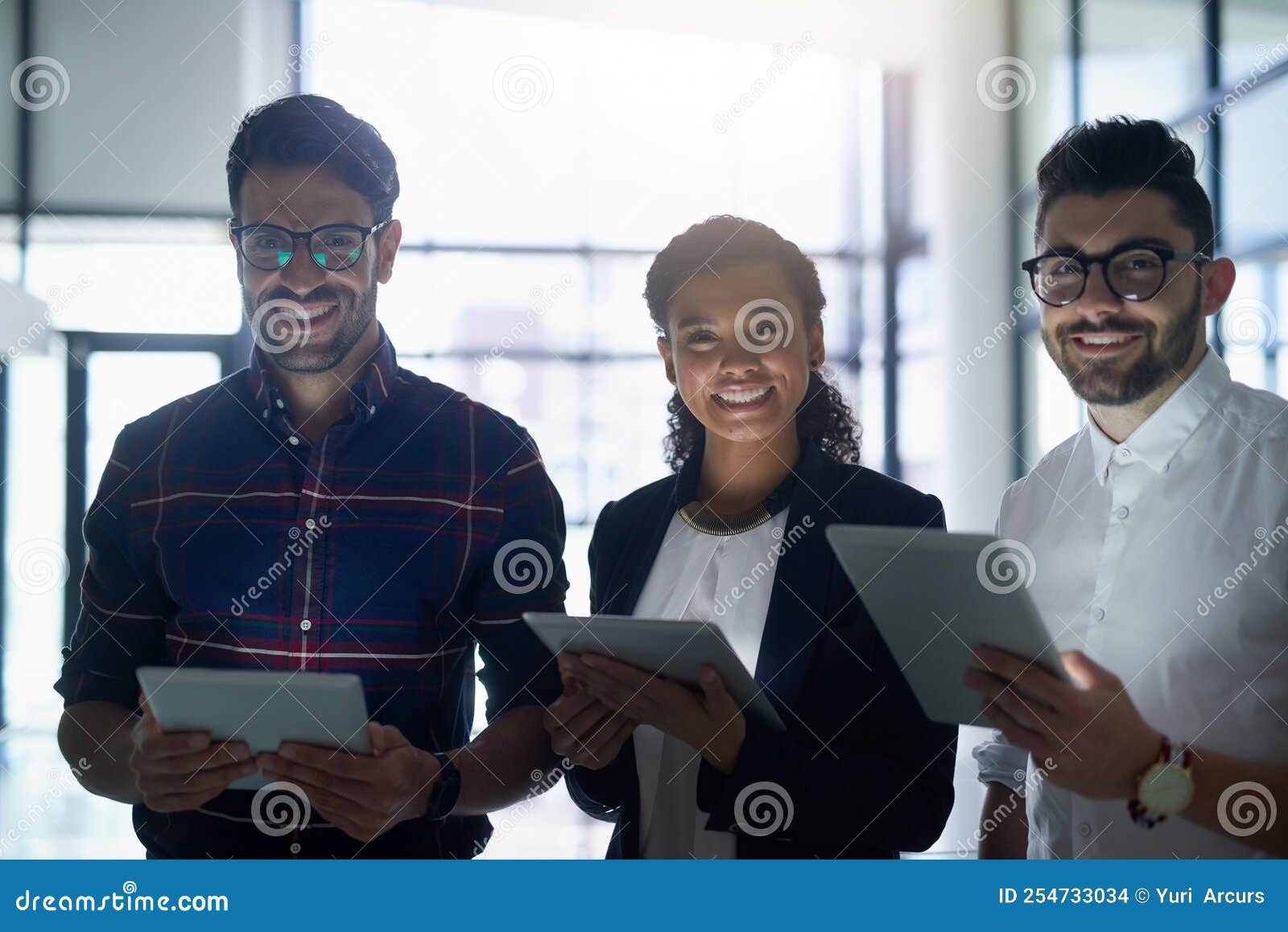 Sharing Technology and Success As a Team. Three Colleagues Using ...