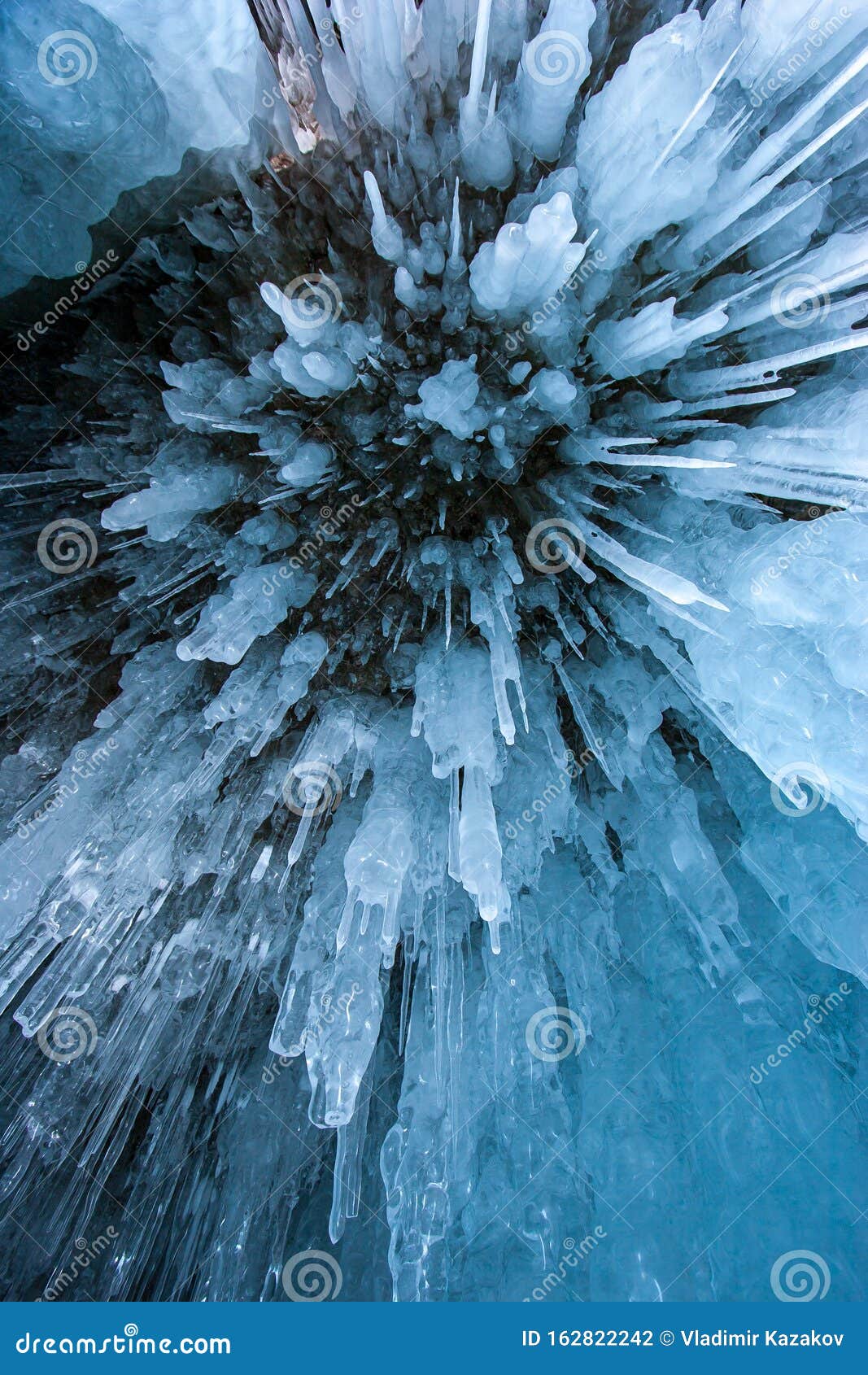 Sharp Blue Icicles Hanging from the Ceiling of the Cave. Stock Photo ...
