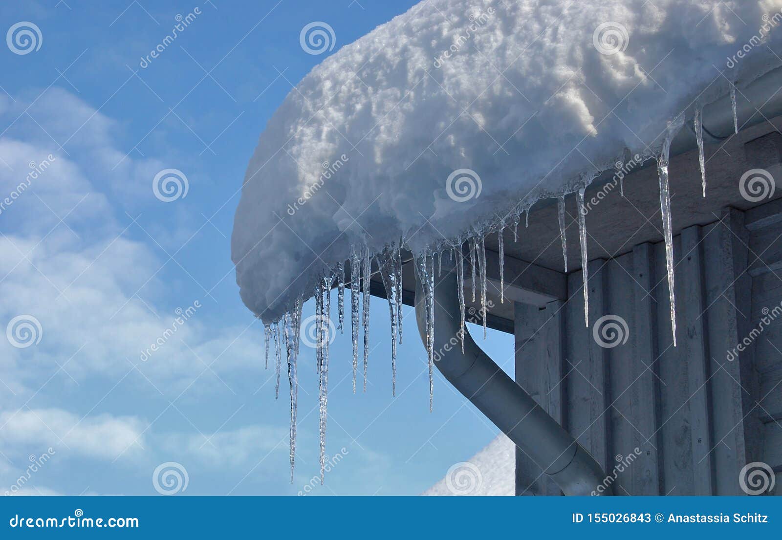 Sharp Bright Icicles and Melted Snow Hanging from Eaves of Roof with ...