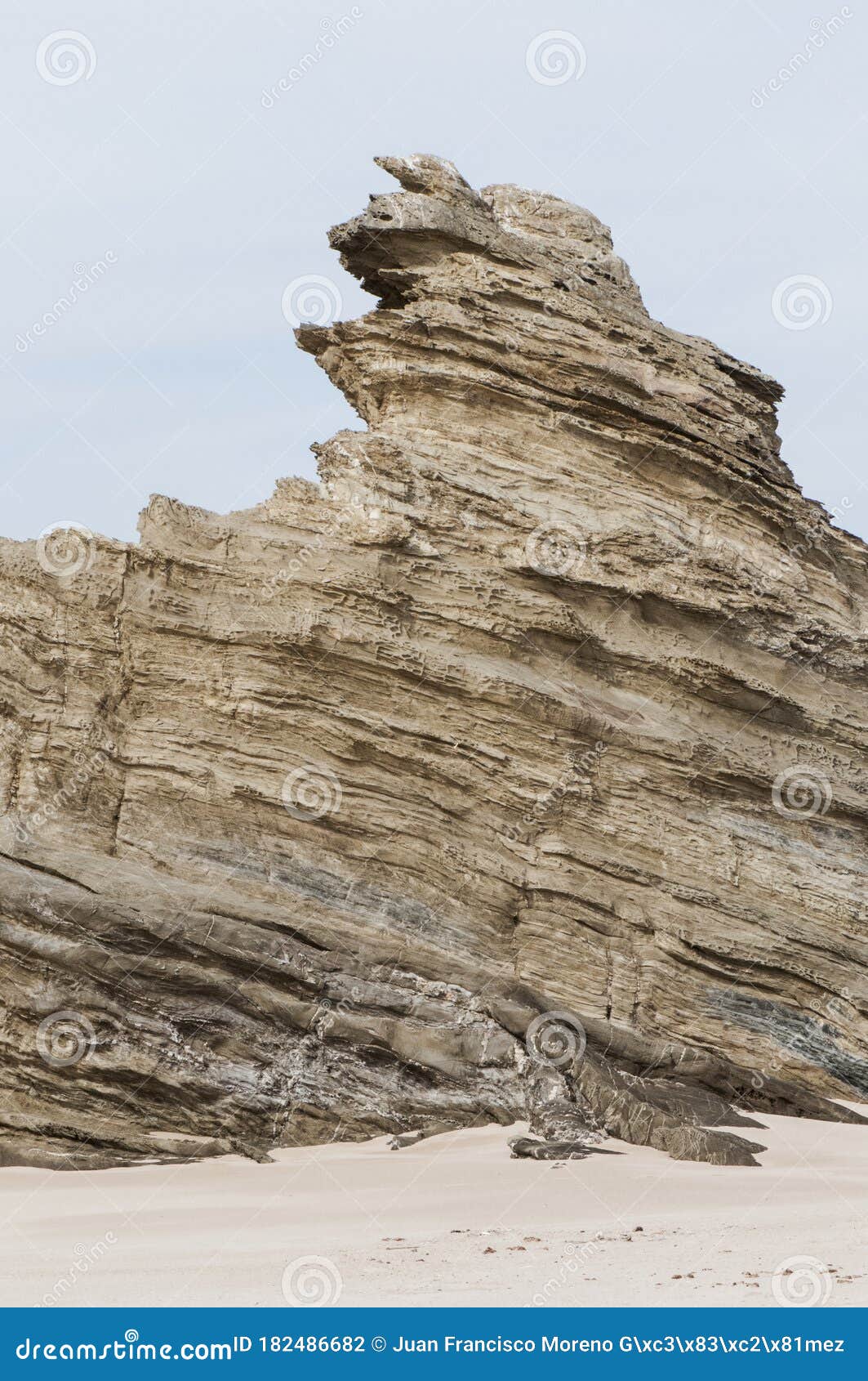Sharp and Eroded Rock Emerging from the Beach Stock Photo - Image of ...