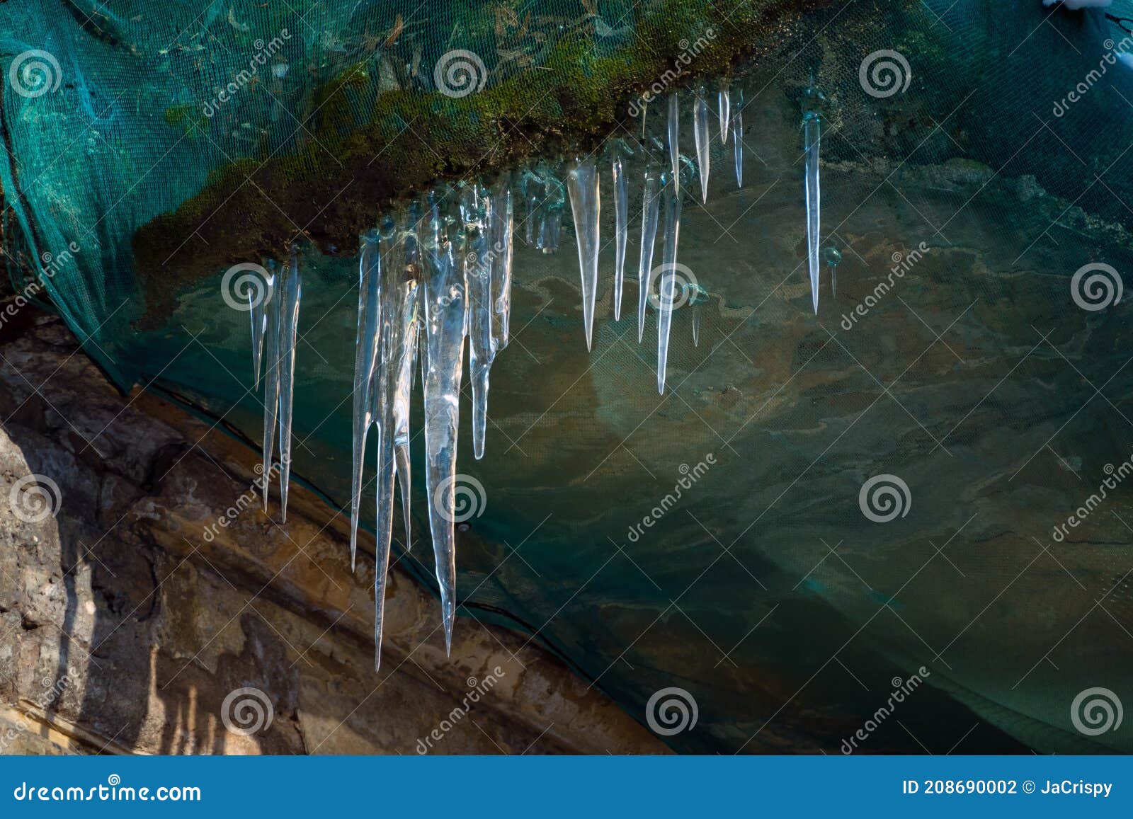 Sharp Icicles Hanging on the Edge of the Balcony. Melting Snow Forms ...