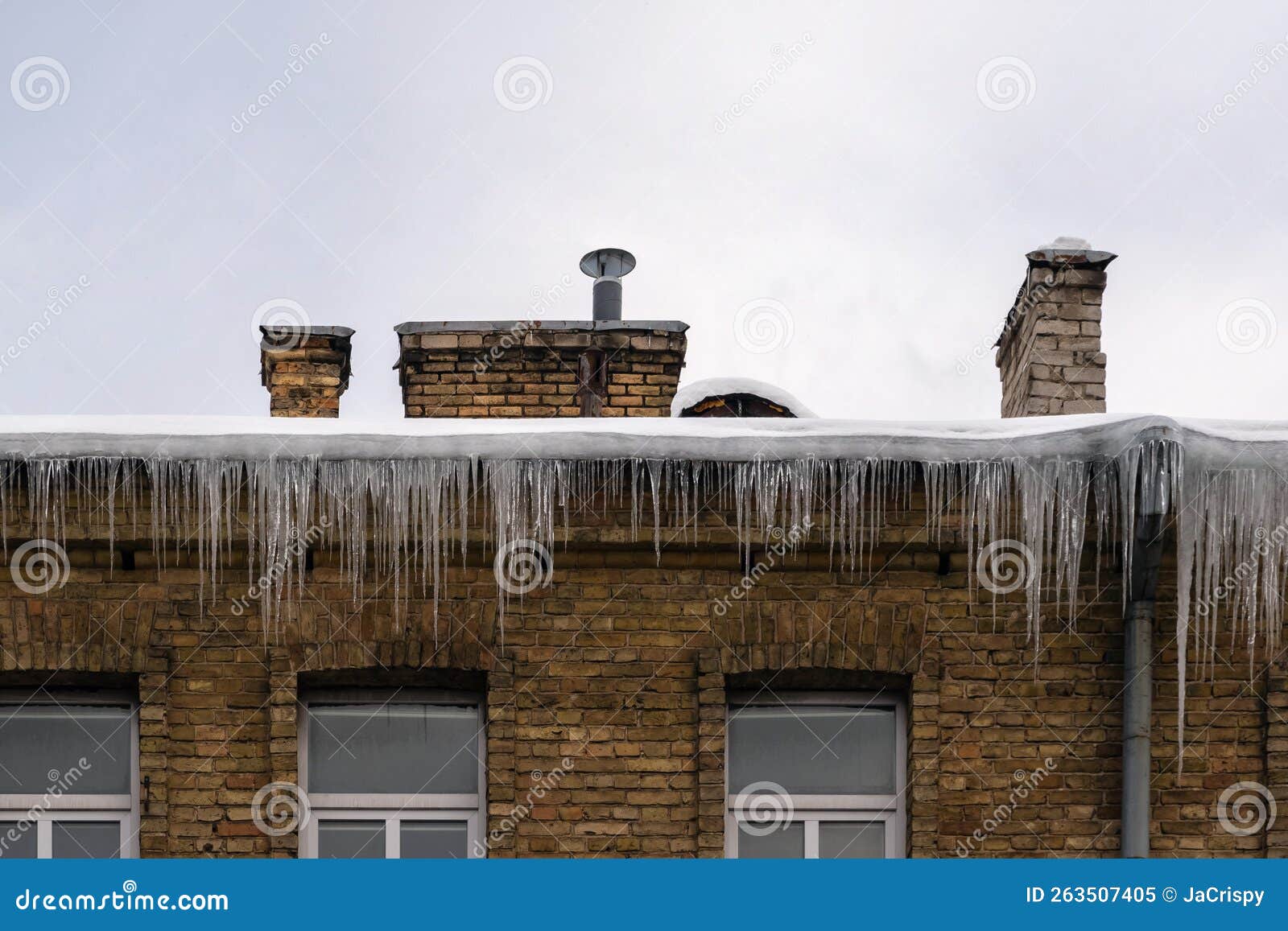 Sharp Icicles Hanging on the Edge of the Roof. Melting Snow Forms ...