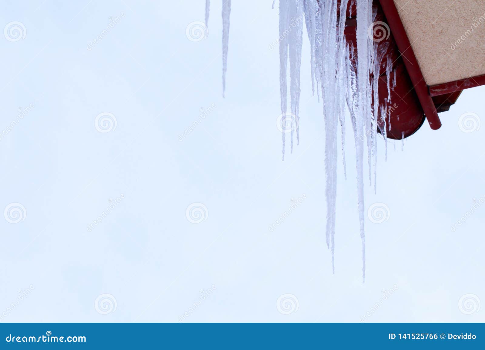 Icicles on the roof stock photo. Image of beautiful - 141525766