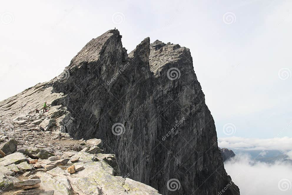 Sharp Peak of a Big Rocky Mountain Against the Bright Sky with Clouds ...