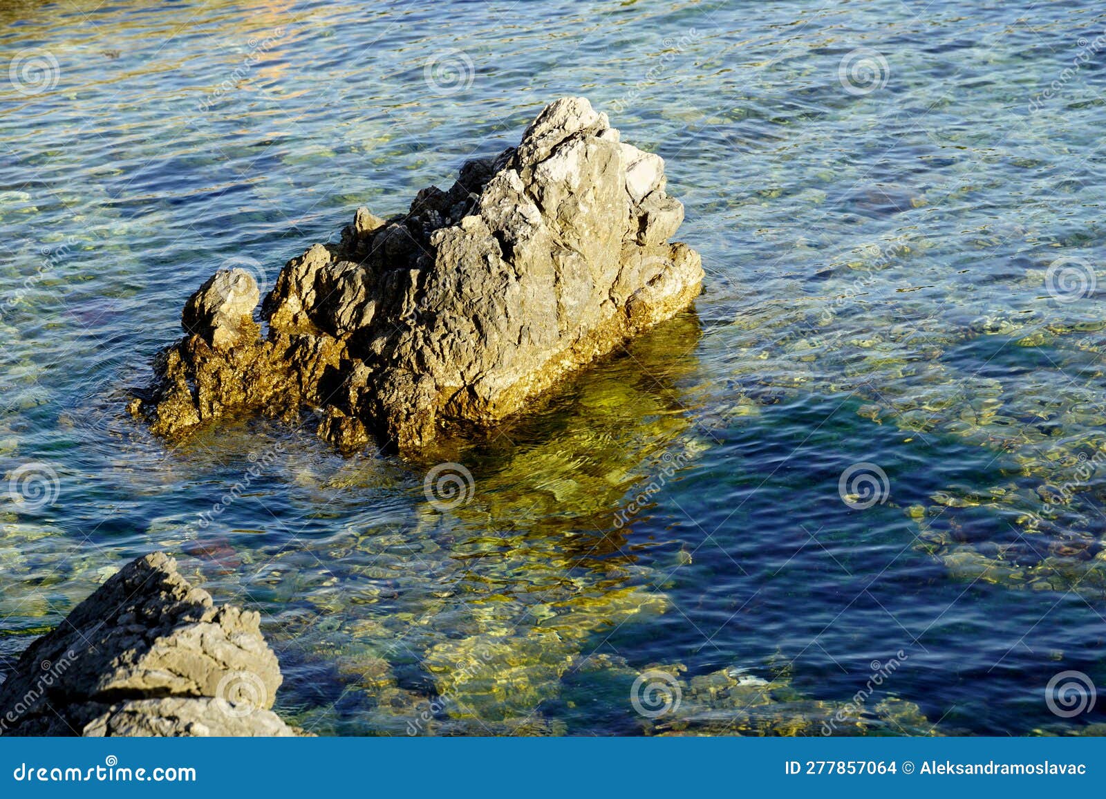 Sharp Rocks Emerging from Shallow Transparent Sea Water Stock Photo ...