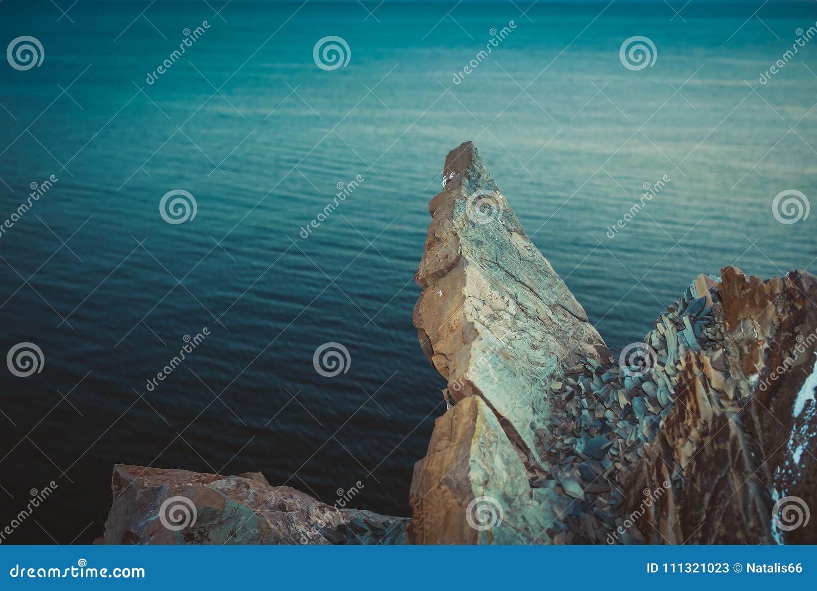 Sharp Rocks Over Water. Blue Toned Image. Stock Image - Image of ...
