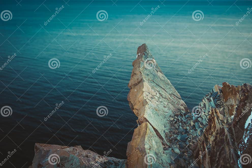 Sharp Rocks Over Water. Blue Toned Image. Stock Image - Image of ...