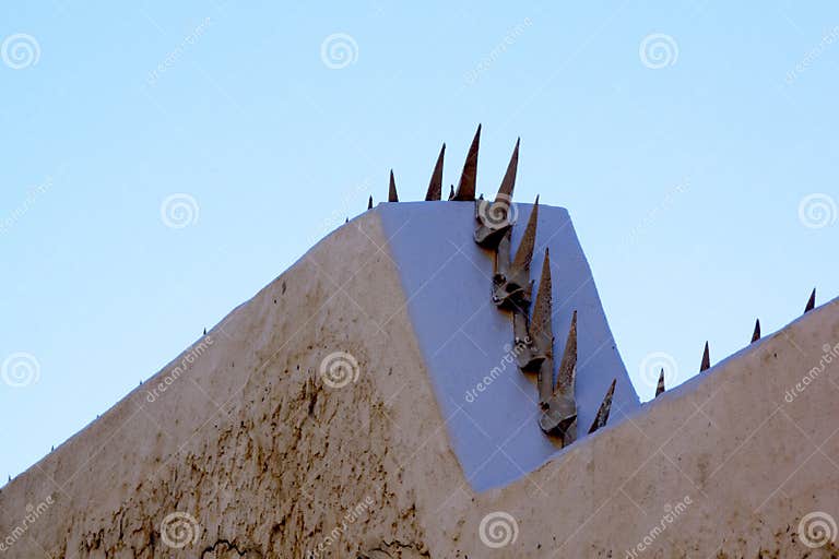 Sharp Rusty Spikes on Residential Boundary Wall Stock Photo - Image of ...