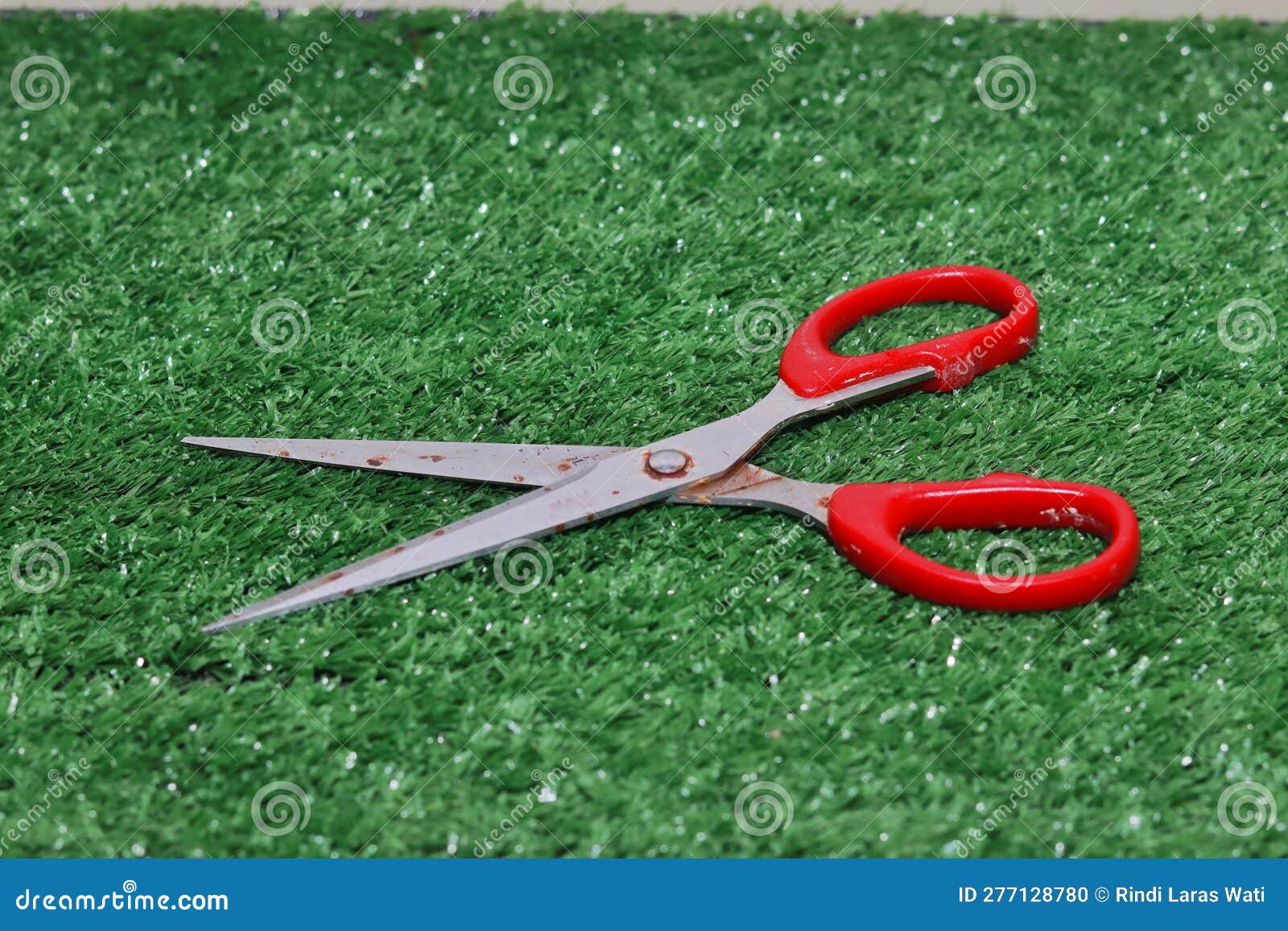 Sharp scissors on grass stock photo. Image of conceptual - 277128780