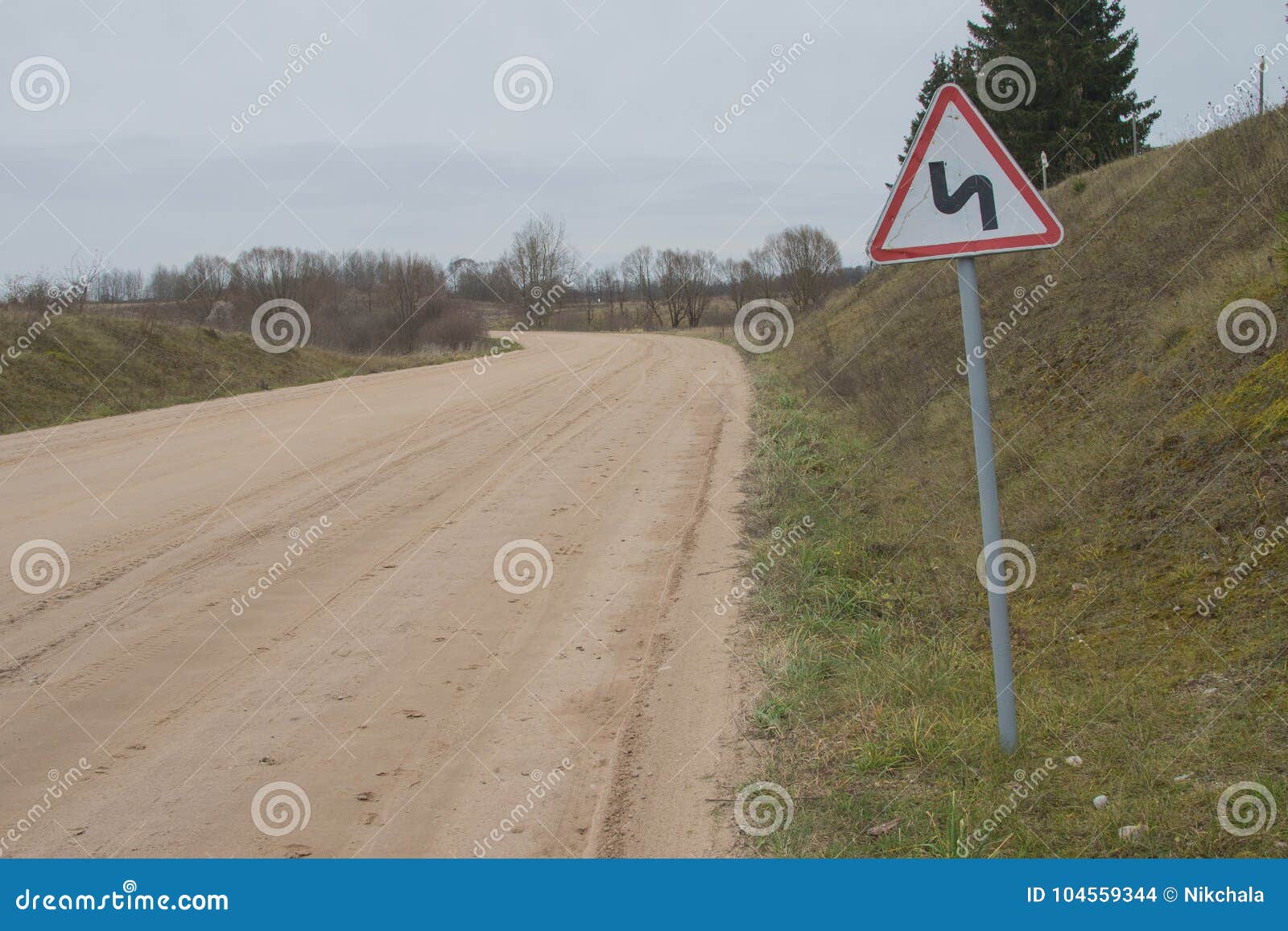 Sharp Turn with Warning Sign on a Gravel Road. Stock Photo - Image of ...
