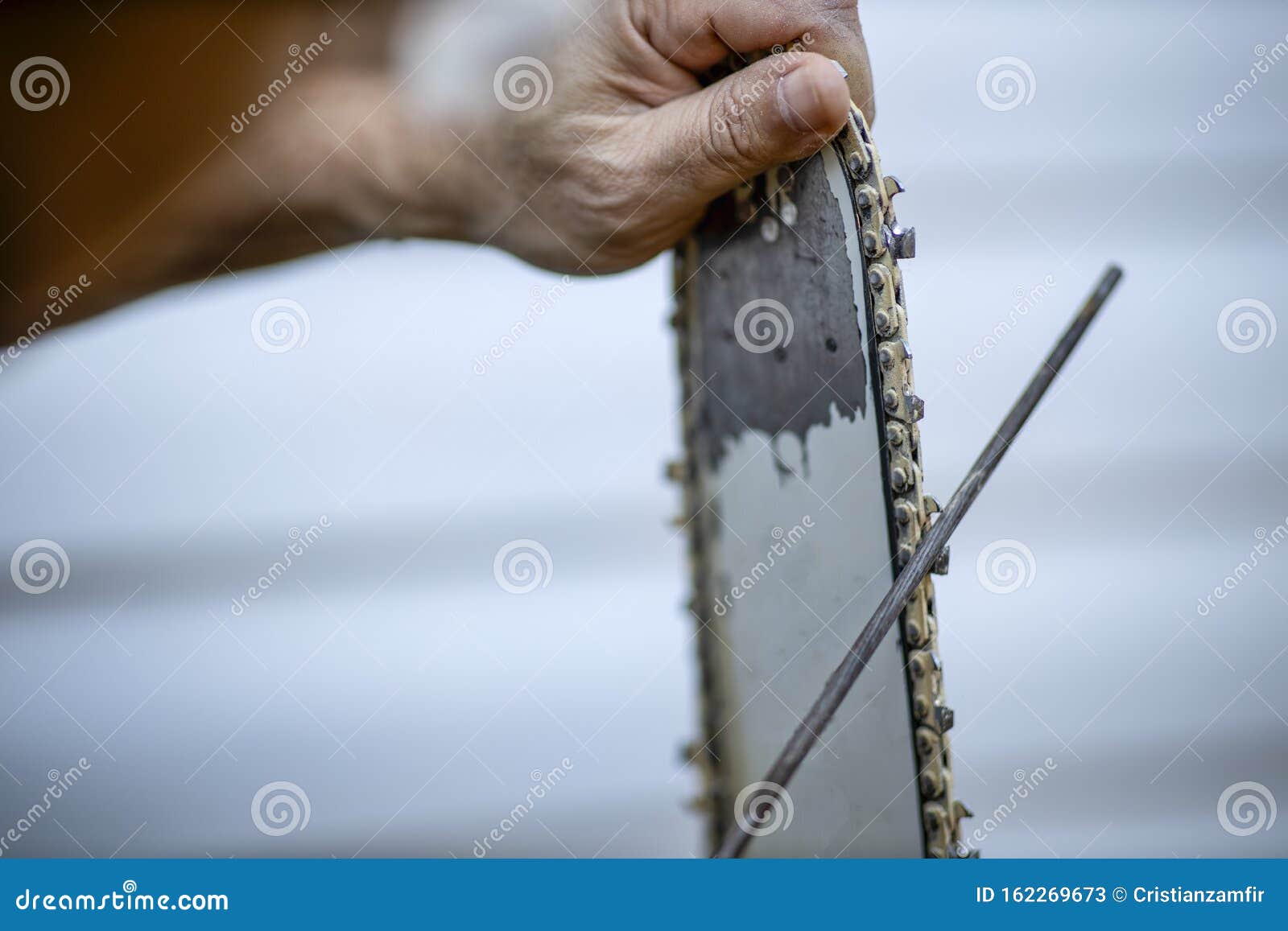 Sharpening a chainsaw stock image. Image of replacement - 162269673
