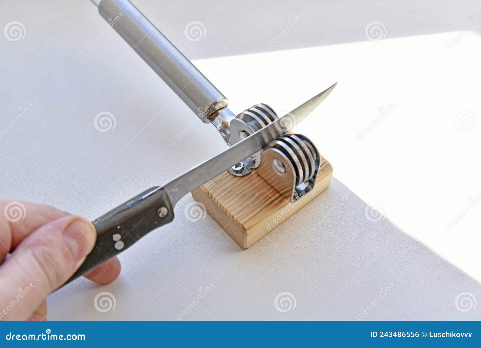 Sharpening an Iron Knife with a Sharpener Stock Photo - Image of ...