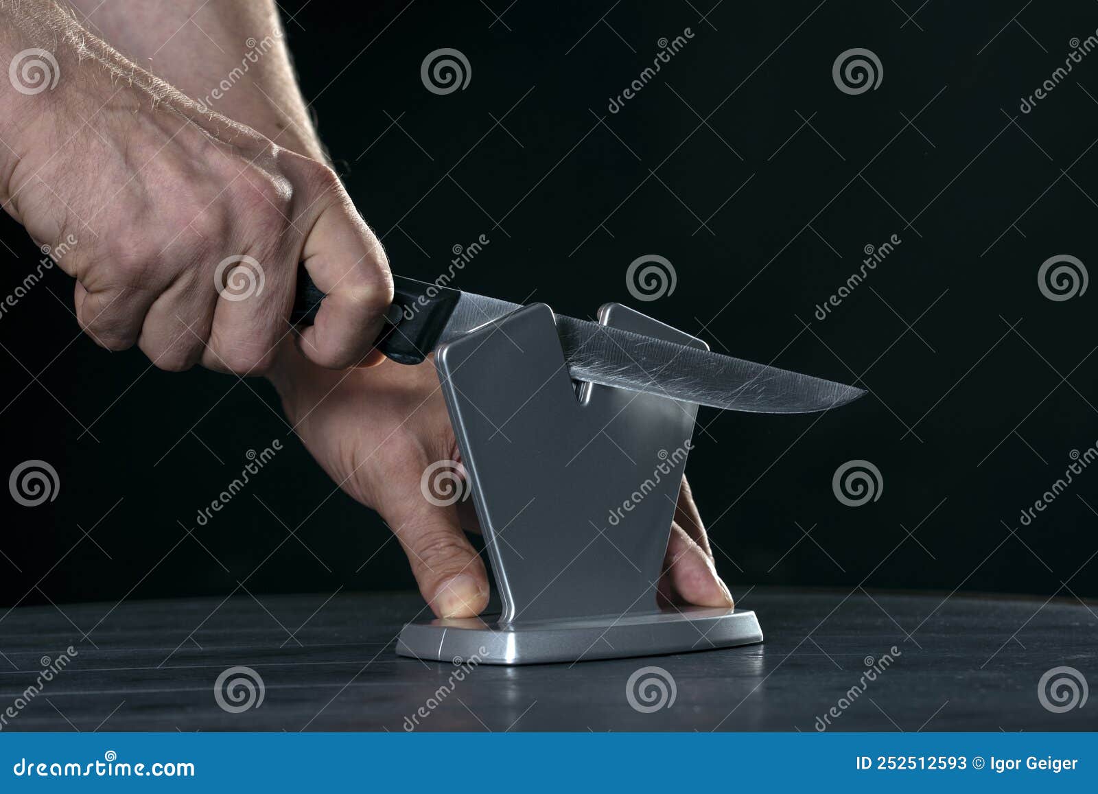 Sharpening Kitchen Knives on a Portable Desktop Machine Stock Image ...