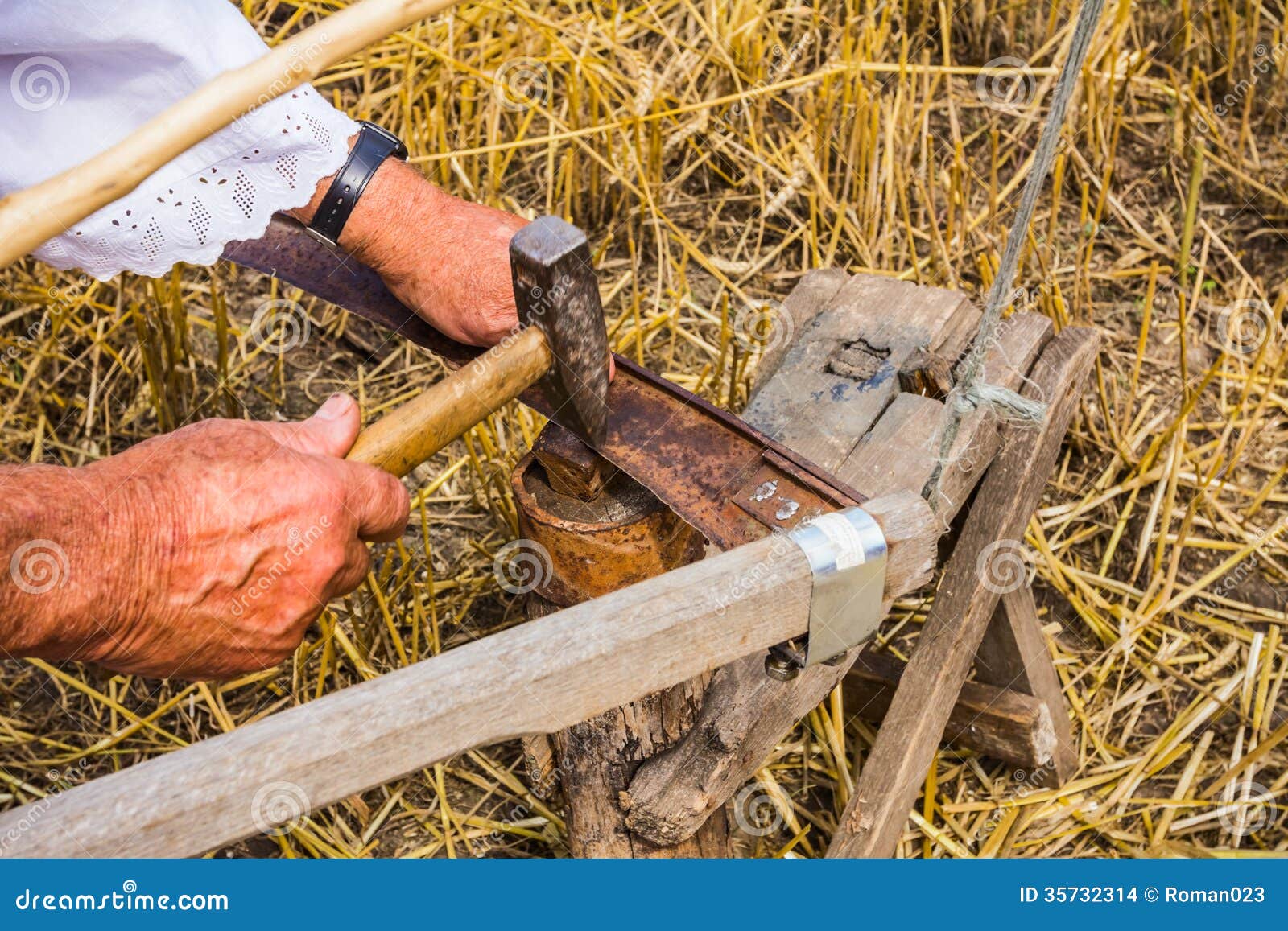Sharpening a scythe stock photo. Image of agriculture - 35732314