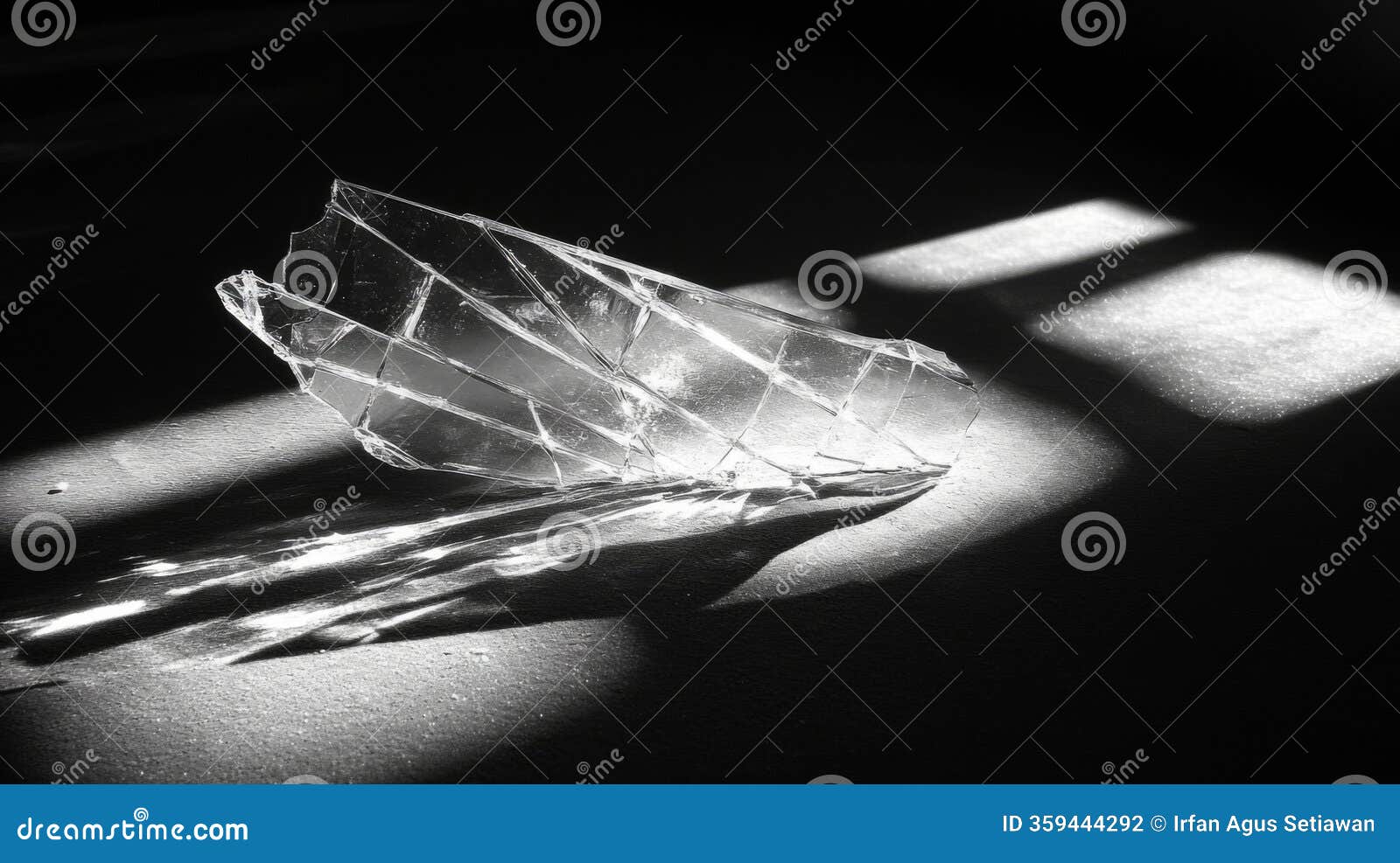 Shattered Glass Fragments in Dramatic Light and Shadow Stock ...