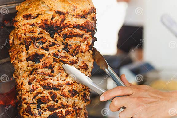 Shawarma meat being cut stock photo. Image of roasted - 77763220