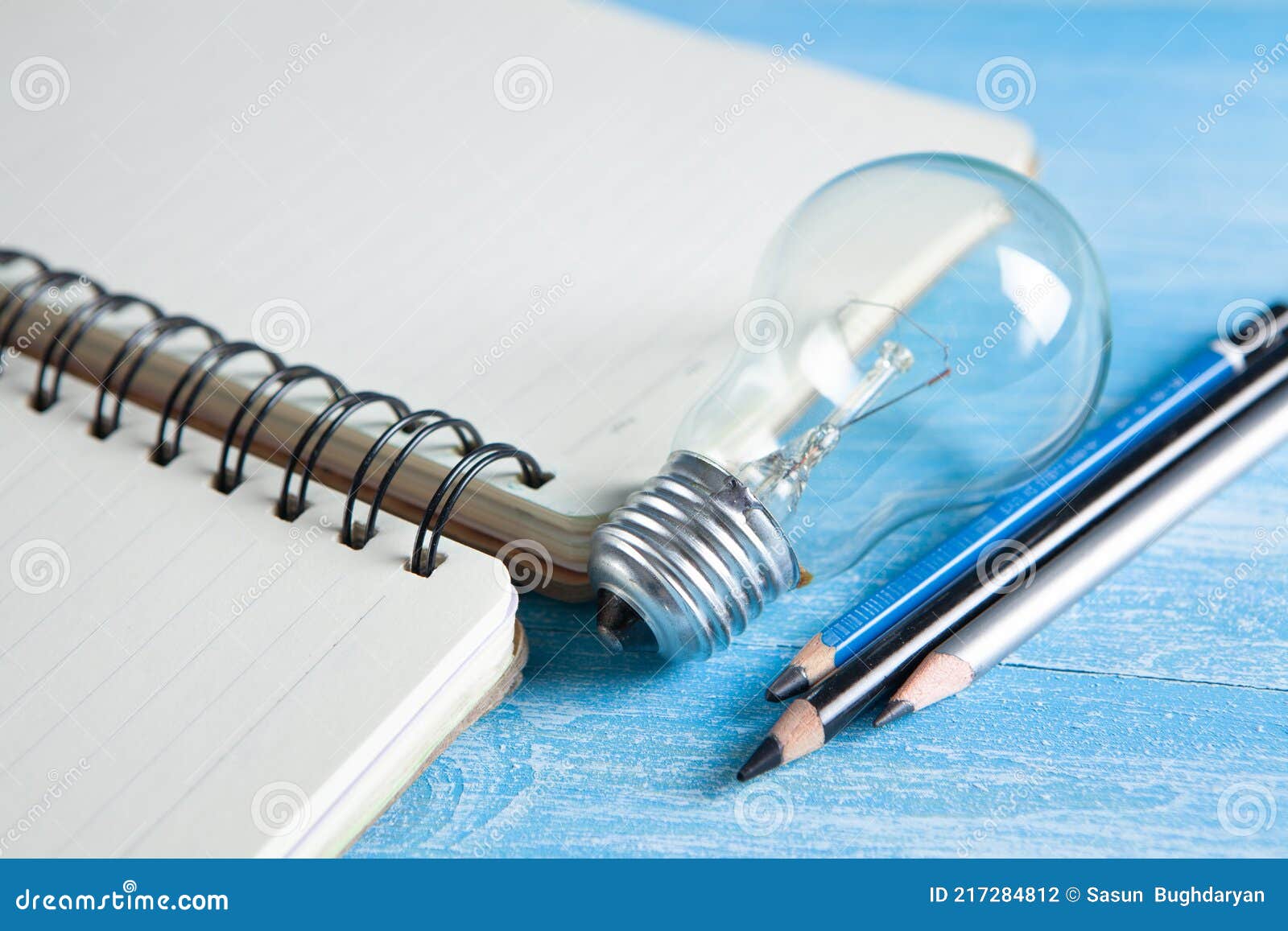 Sheet with a Notebook with Pens and a Light Bulb on the Table Lk. New ...