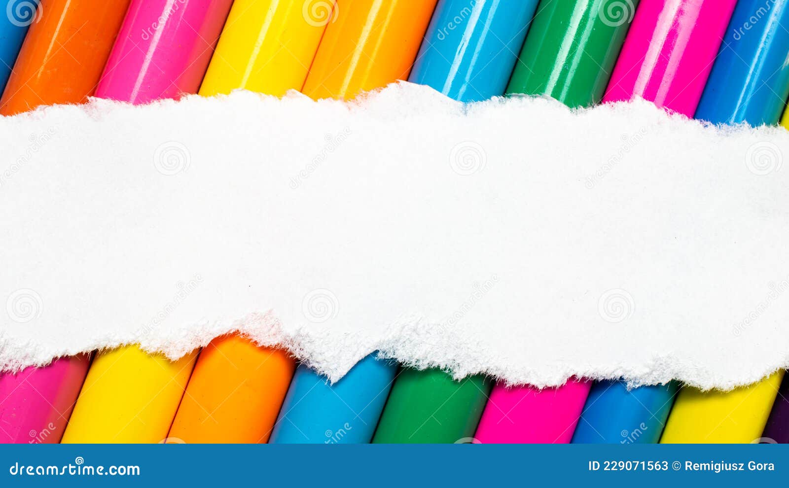 A Sheet of White Paper on a Background of Colored Pencils. Label for ...