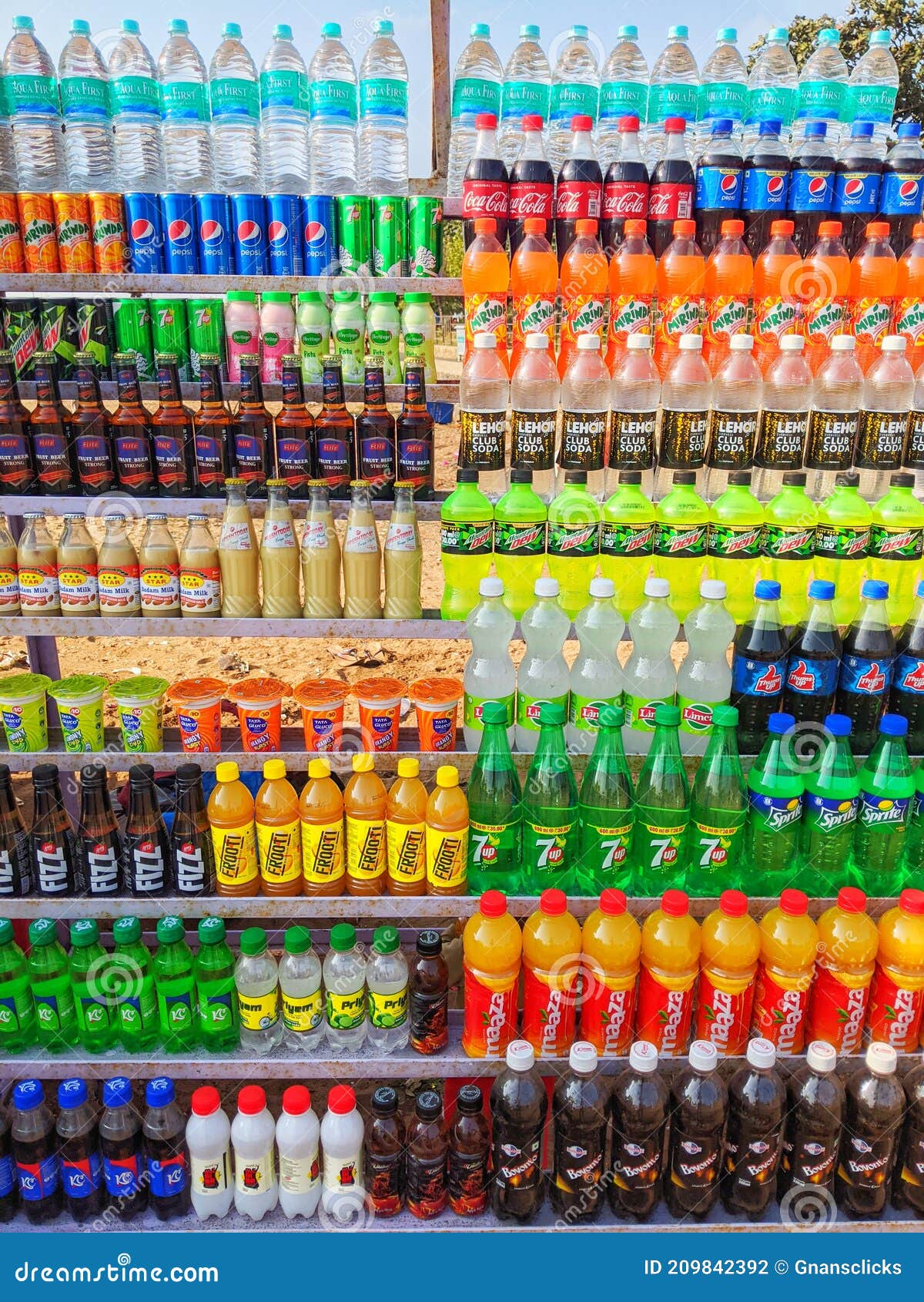 A Shelf of Drinks and Water Bottles in Plastic Container in Open Air at ...