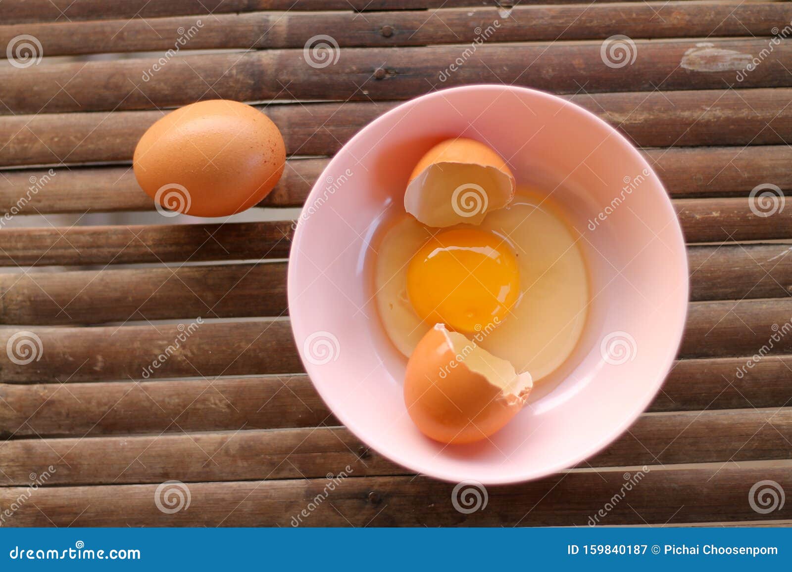 Shell with Egg and Open Eggs in a Pink Bowl on Bamboo Battens. Top View ...