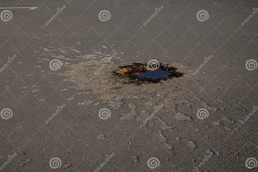A shell hole in the road editorial stock image. Image of danger - 295177969
