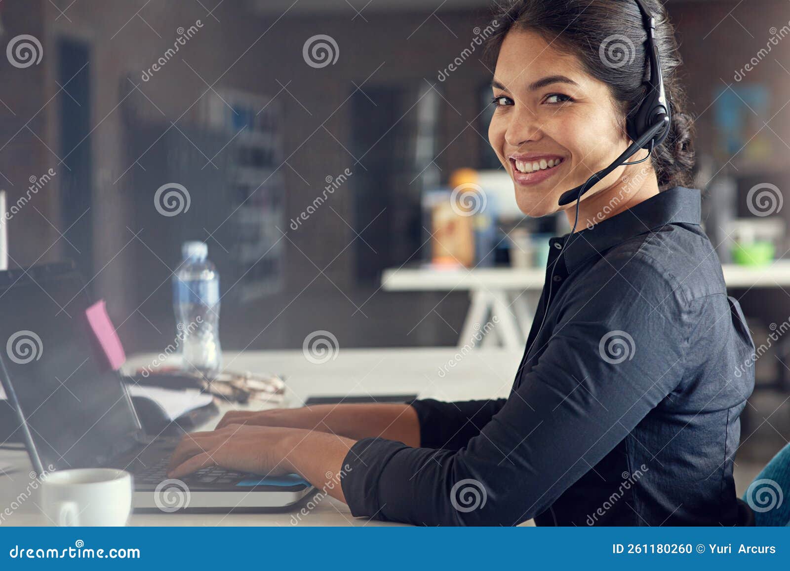 Shes Above and Beyond the Call. a Call Centre Agent Sitting at Her Desk ...
