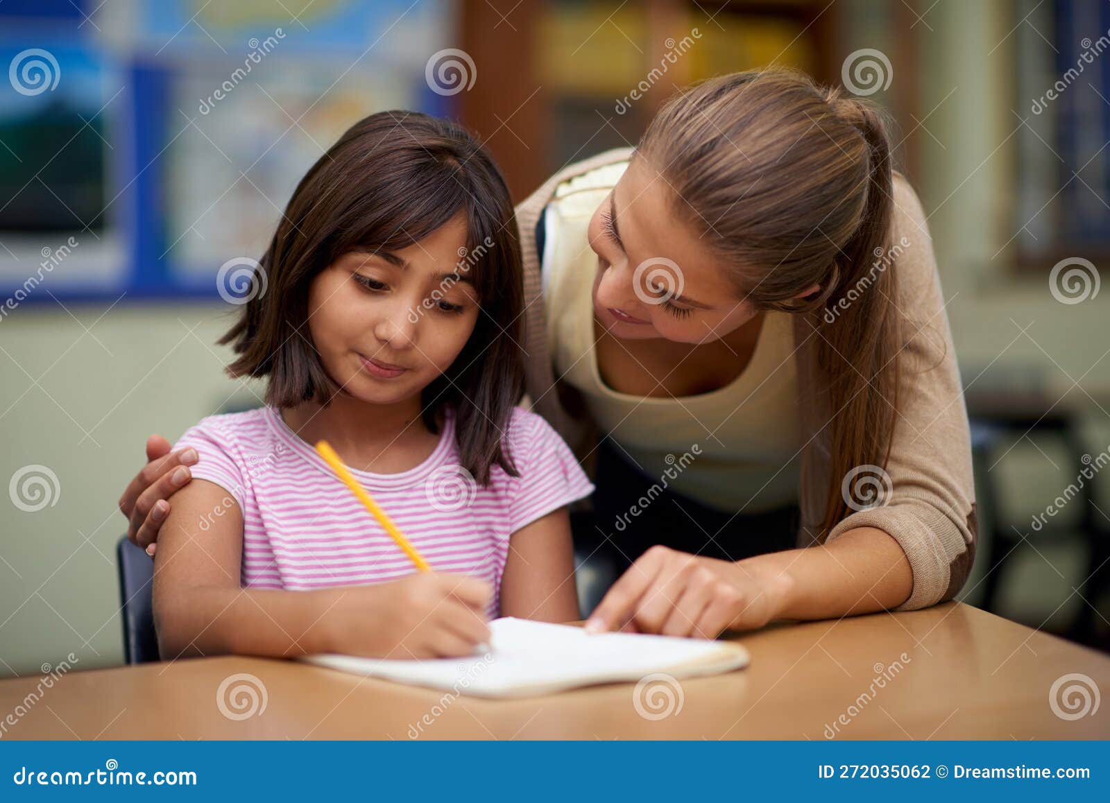 Shes a Dedicated Educator. a Teacher Helping Her Student with Her Work ...