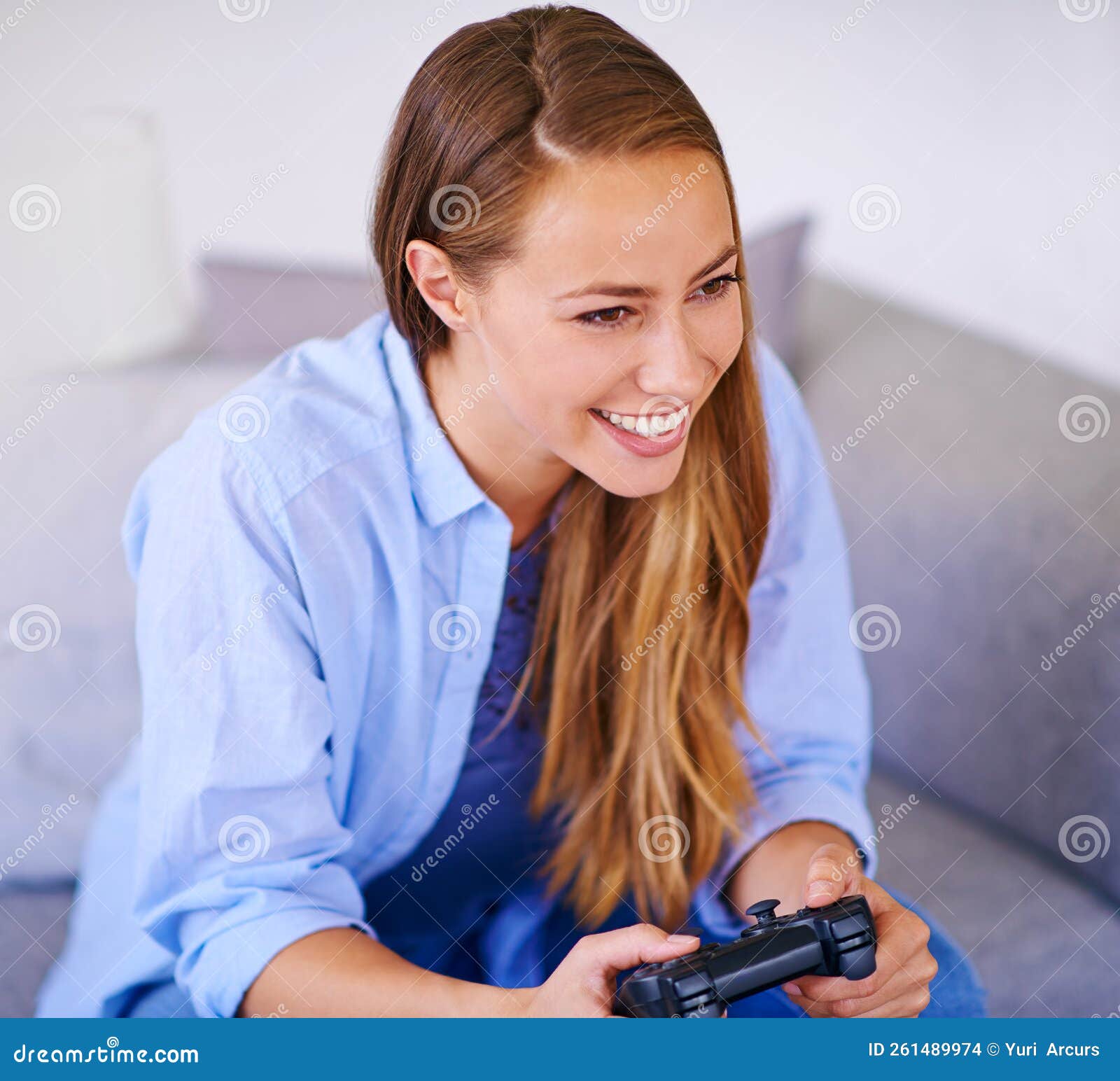 Shes really Getting into the Game. a Young Woman Holding a Video Game ...
