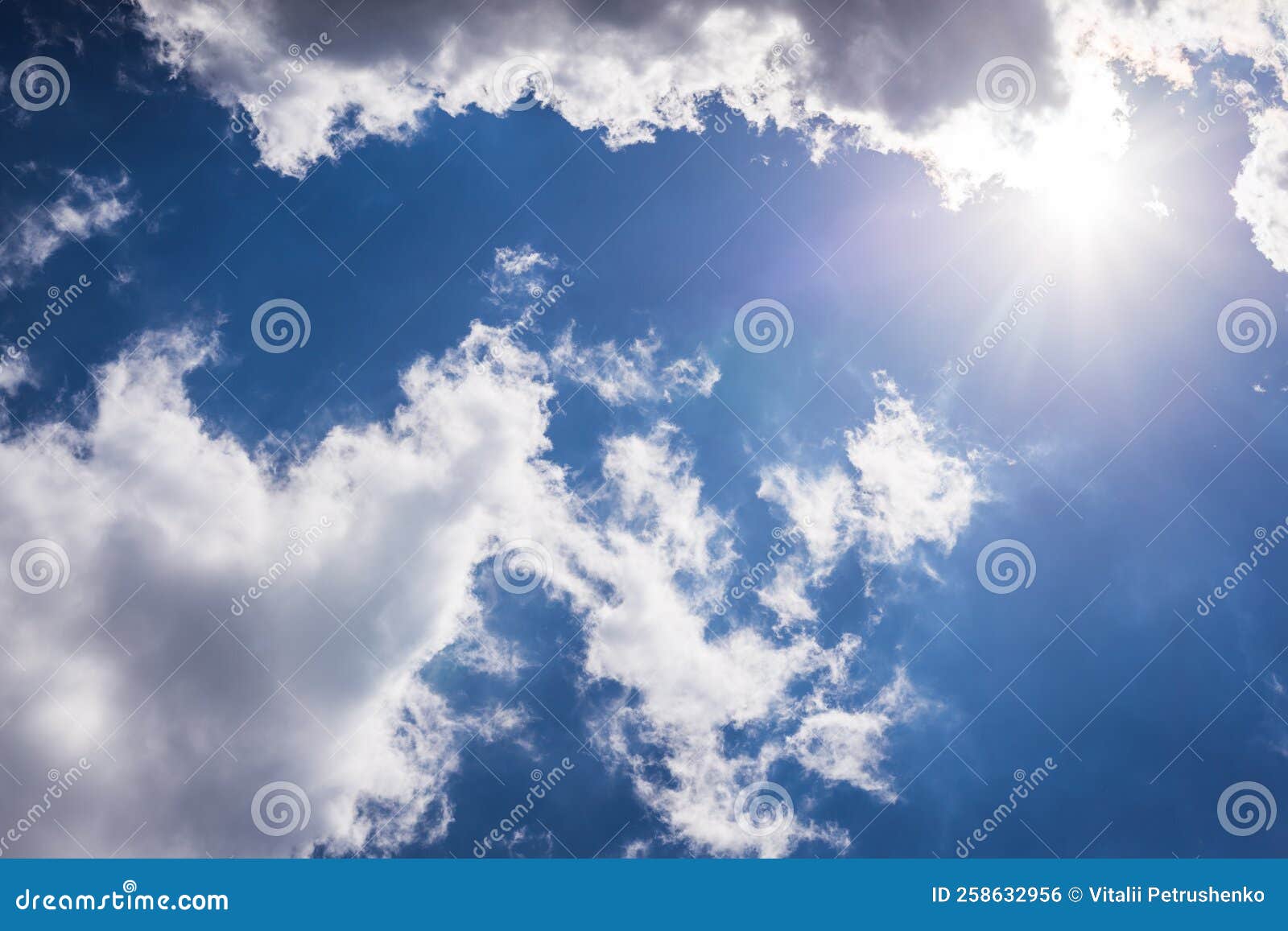 Shining sun through clouds stock photo. Image of space - 258632956