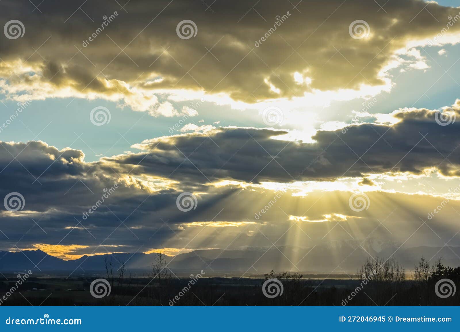 Shining Sun between Clouds during Sundown in a Landscape Stock Image ...