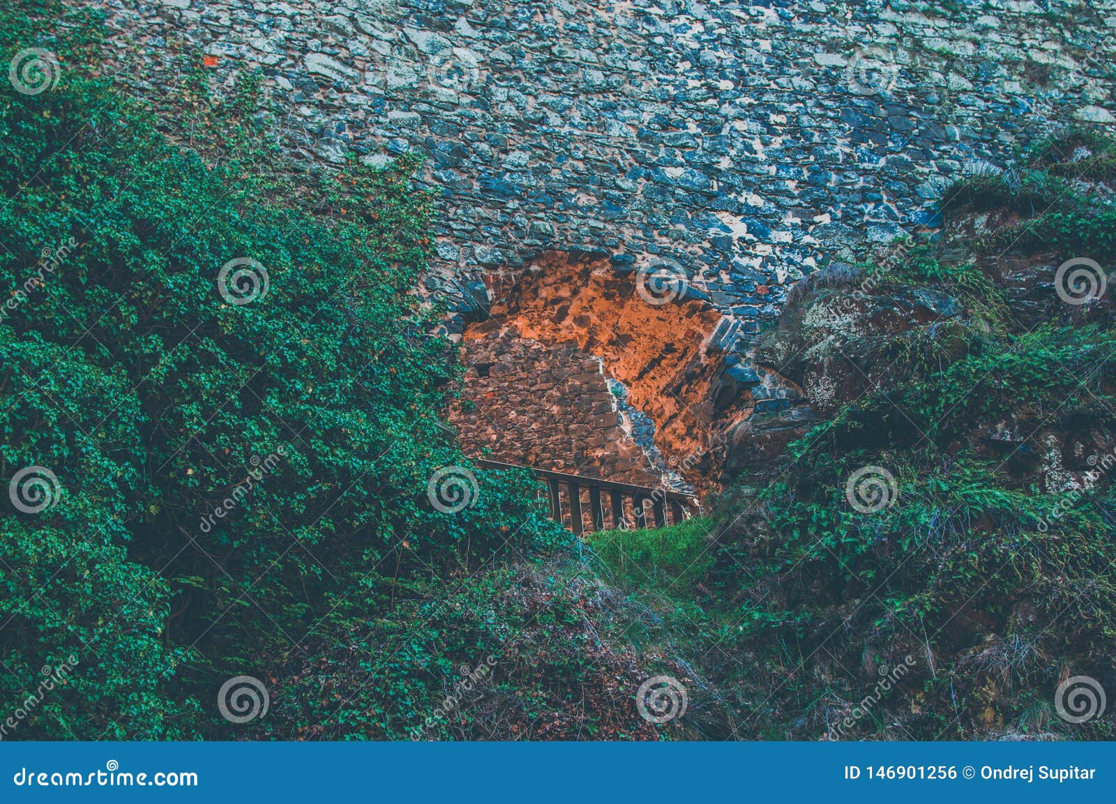 Shining Sun through the Hole in a Rock Solid Wall Stock Photo - Image ...