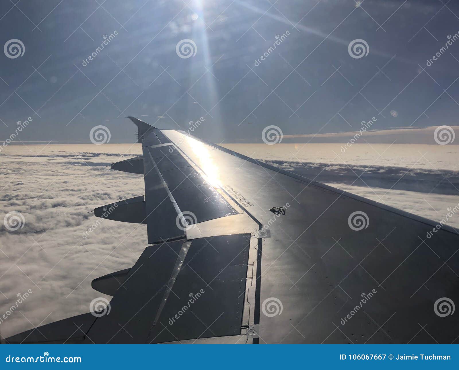 Shiny Airplane Wing Over Clouds Stock Image - Image of sunlight, scenic ...