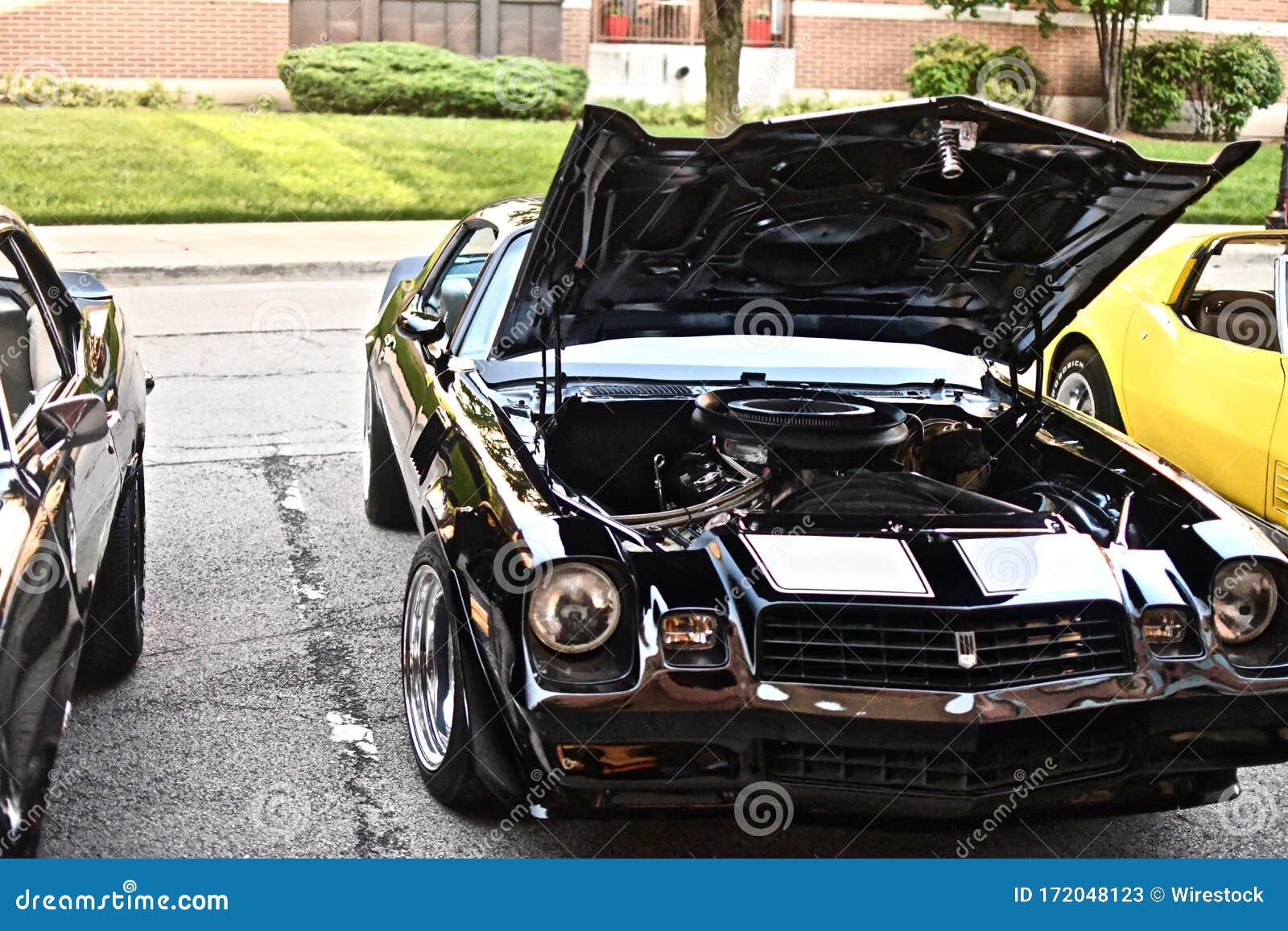 Shiny Black Car with an Open Hood Showing the Car Engine Editorial ...