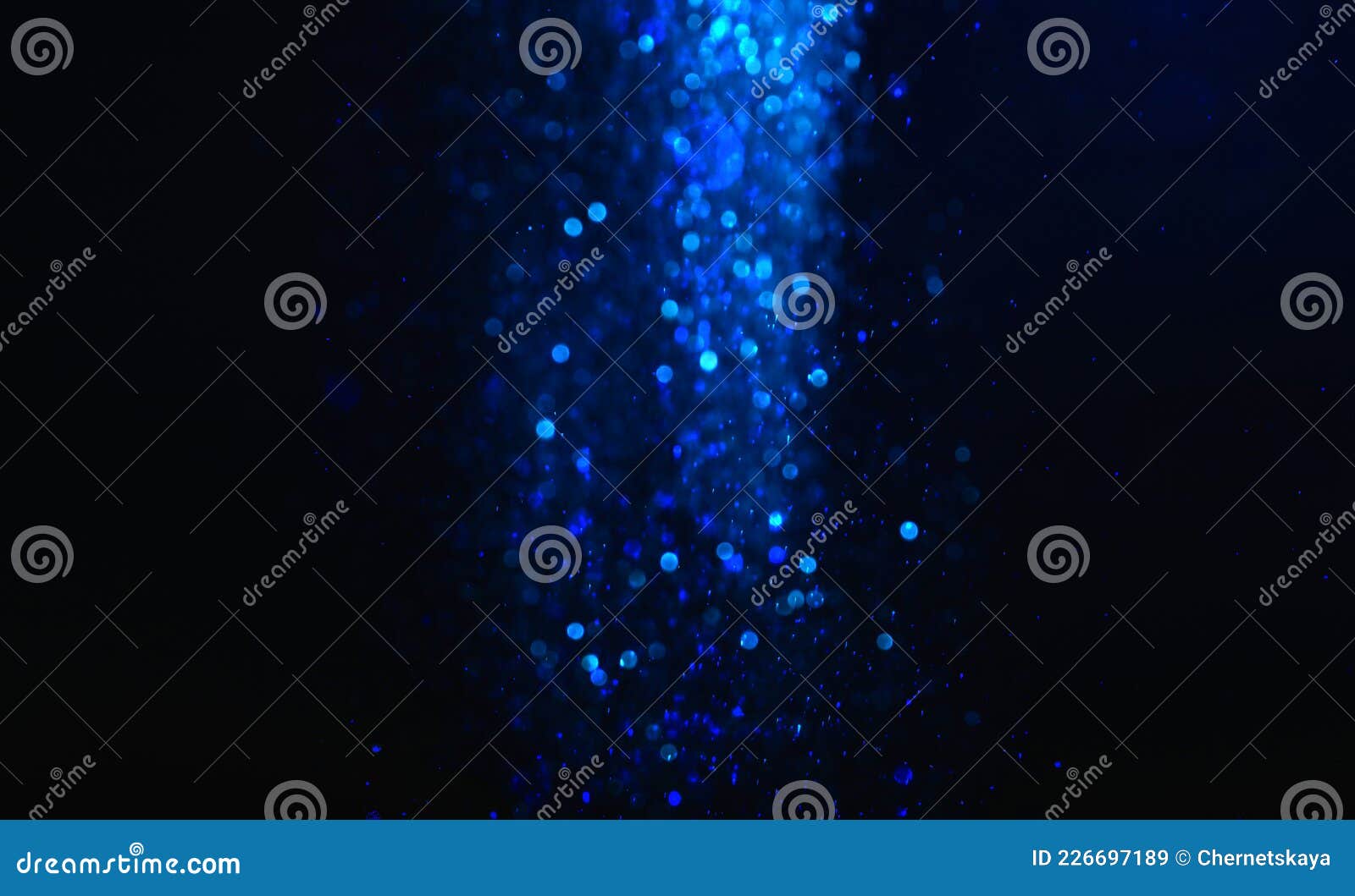 Shiny Blue Glitter Falling Down on Black Background. Bokeh Effect Stock ...