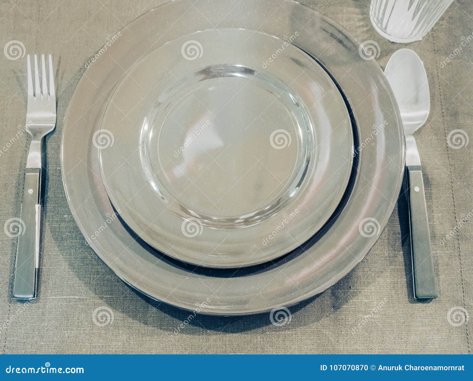 Shiny Ceramic Dish Set with Silver Spoon and Fork Put on Wooden Stock ...