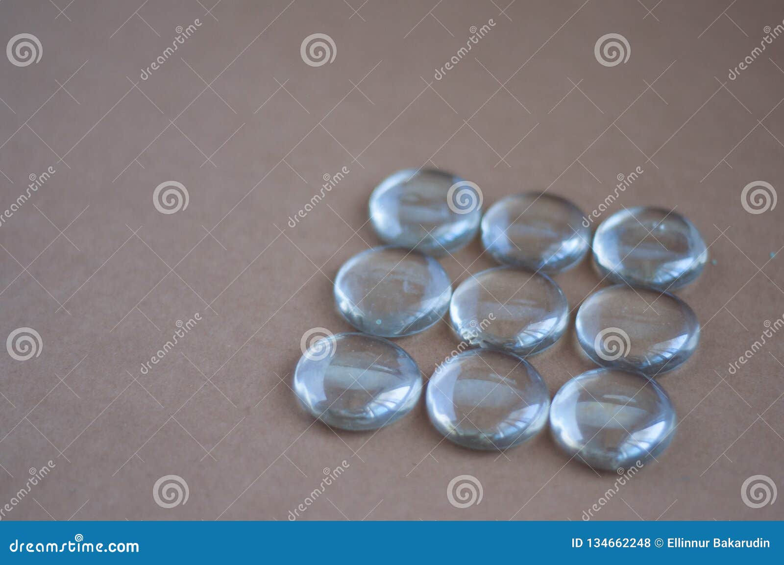 Clear Marbles with Light Reflections on a Brown Background. Stock Photo ...