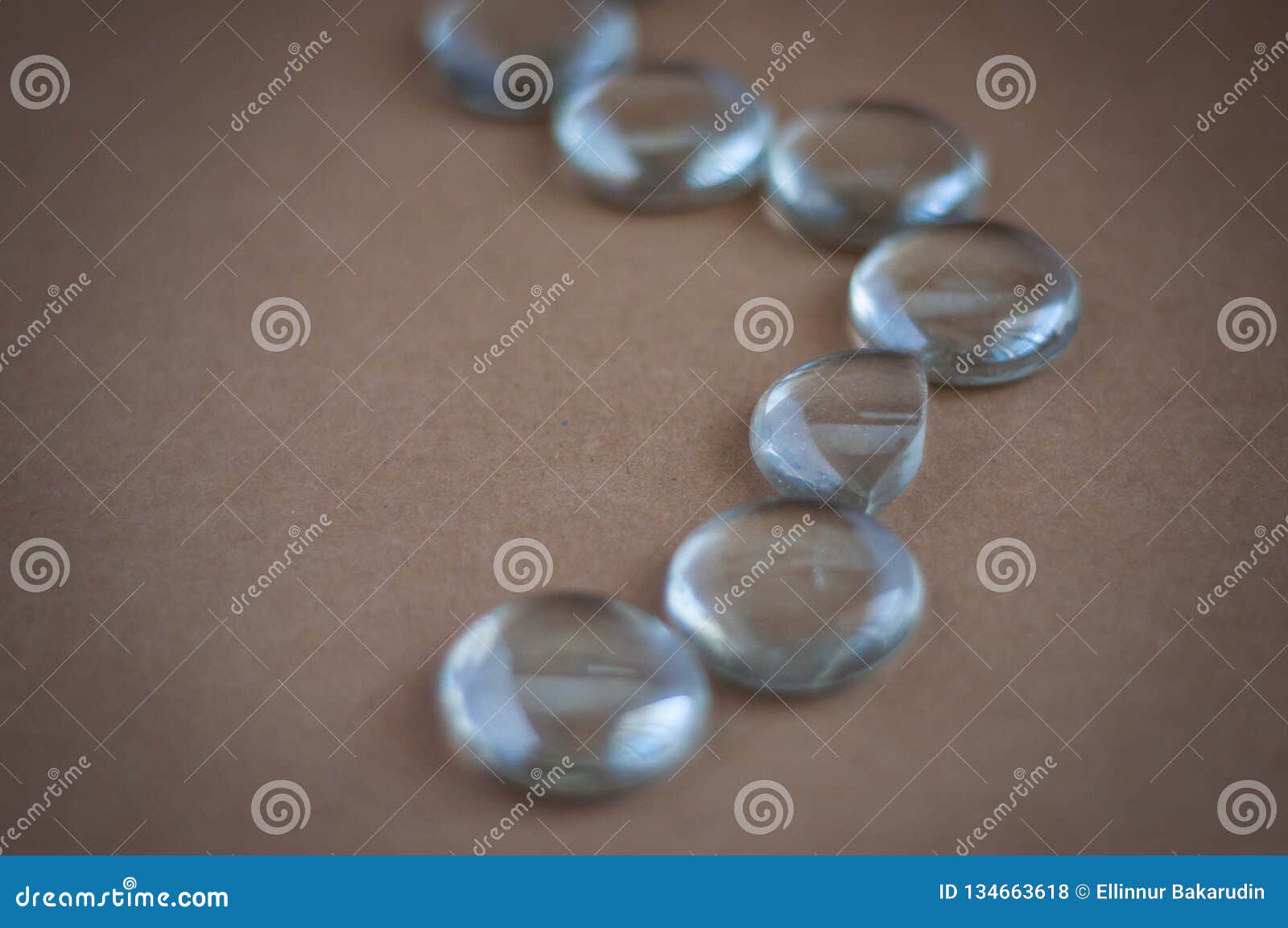 Clear Marbles with Light Reflections on a Brown Background. Stock Photo ...