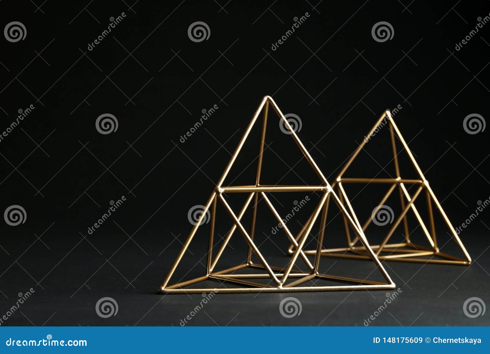 Shiny Decorative Gold Pyramids on Black Background Stock Image - Image ...