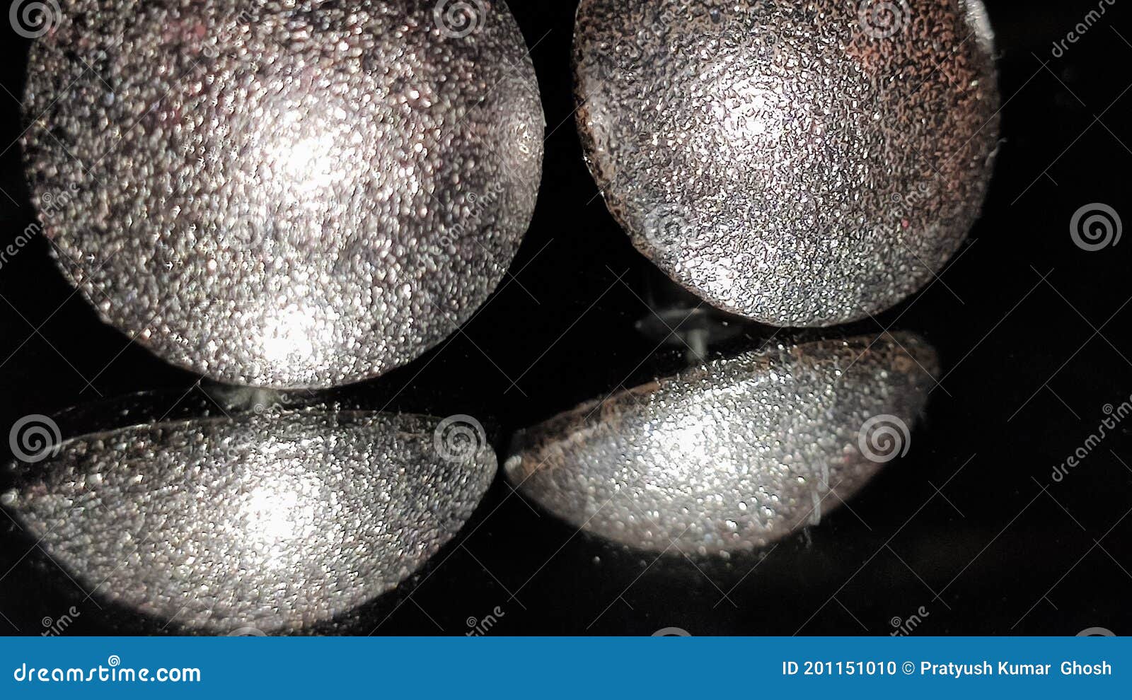 Shiny Ear Rings on a Reflective Surface Stock Photo - Image of ...
