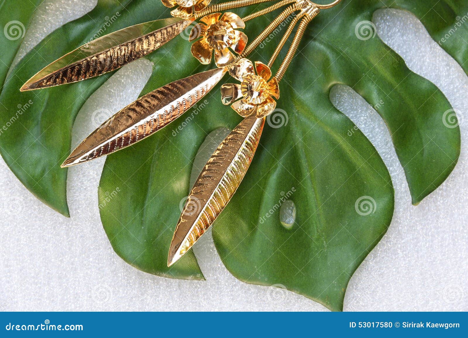 Shiny Gold Flower on Green Leaf Stock Photo - Image of orient ...