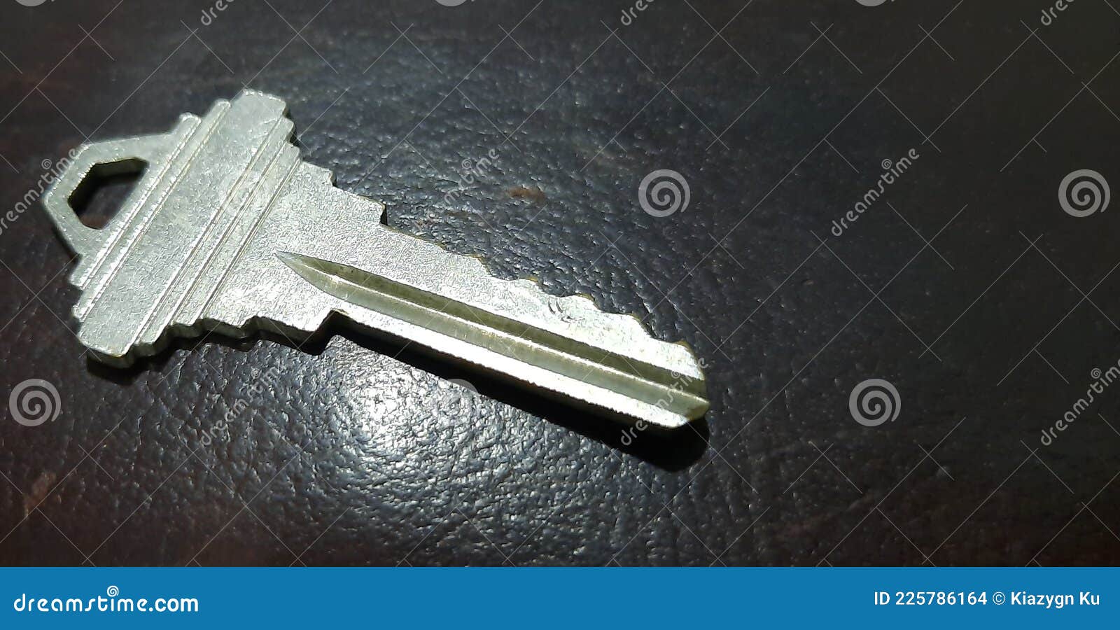 A Shiny Key on a Brown Leather Table Stock Photo - Image of leather ...