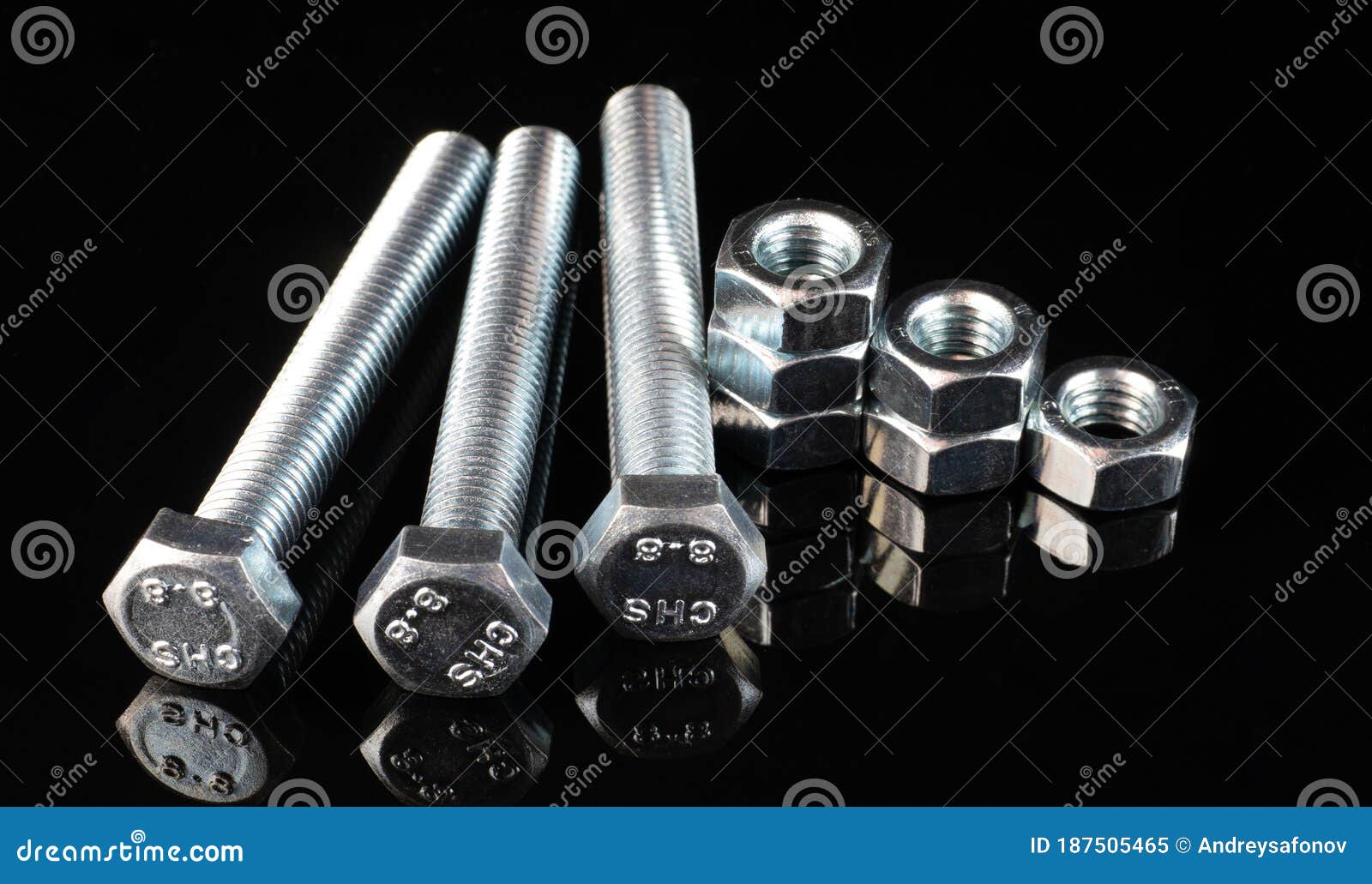 Shiny Metal Bolts and Nuts on a Gray Mirror Background Stock Image ...