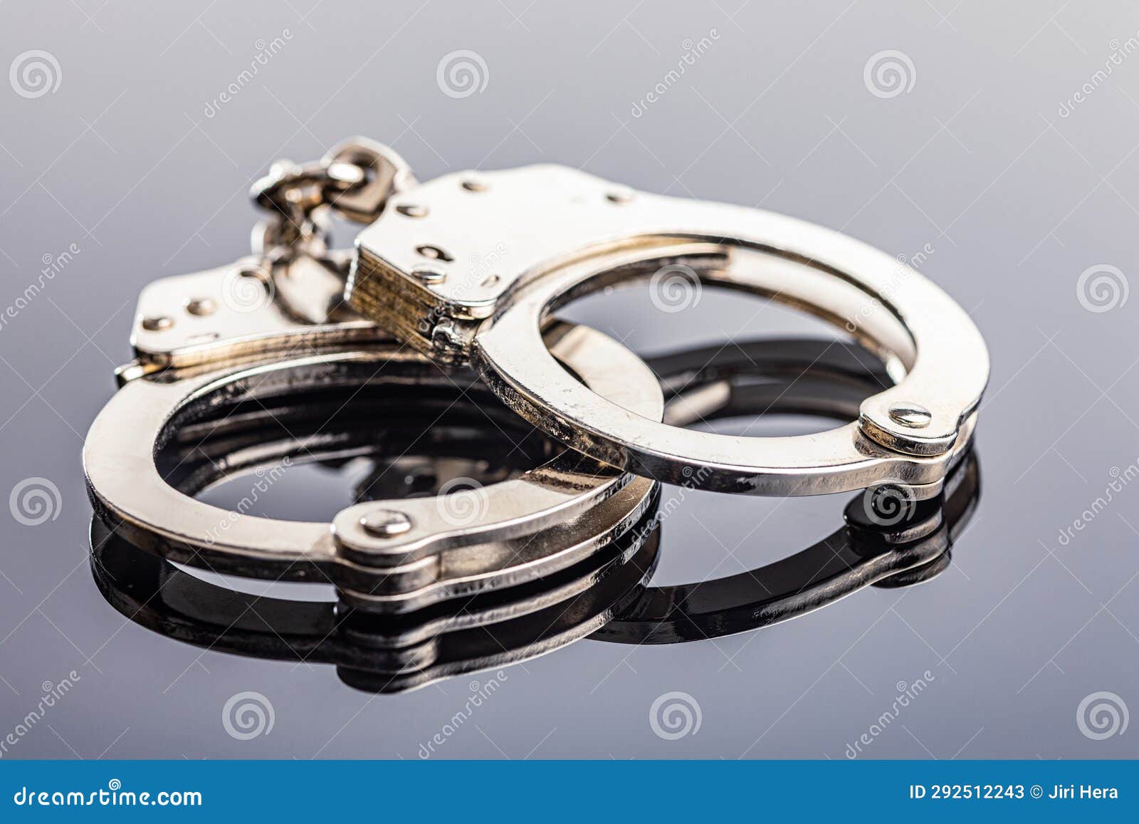 Shiny Metal Handcuffs on Mirror Table Stock Image - Image of shackle ...