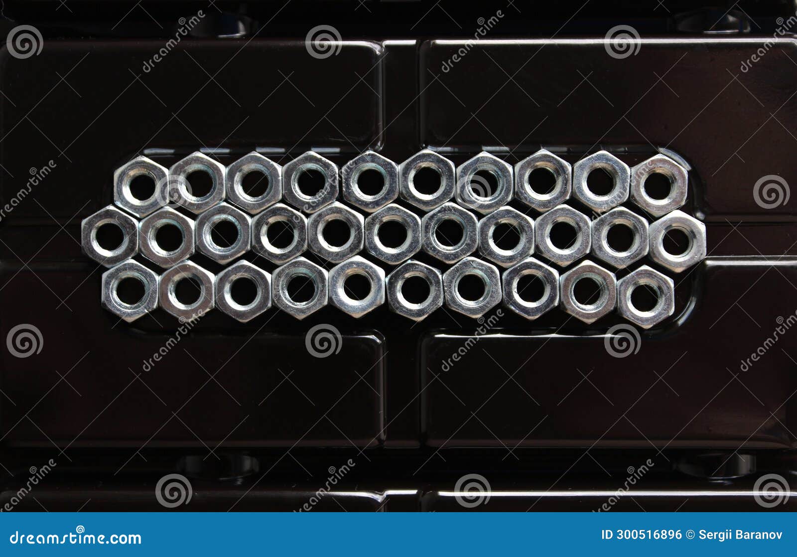 Shiny Metal Nuts in Rectangular Order on Plastic Surface Stock Photo ...