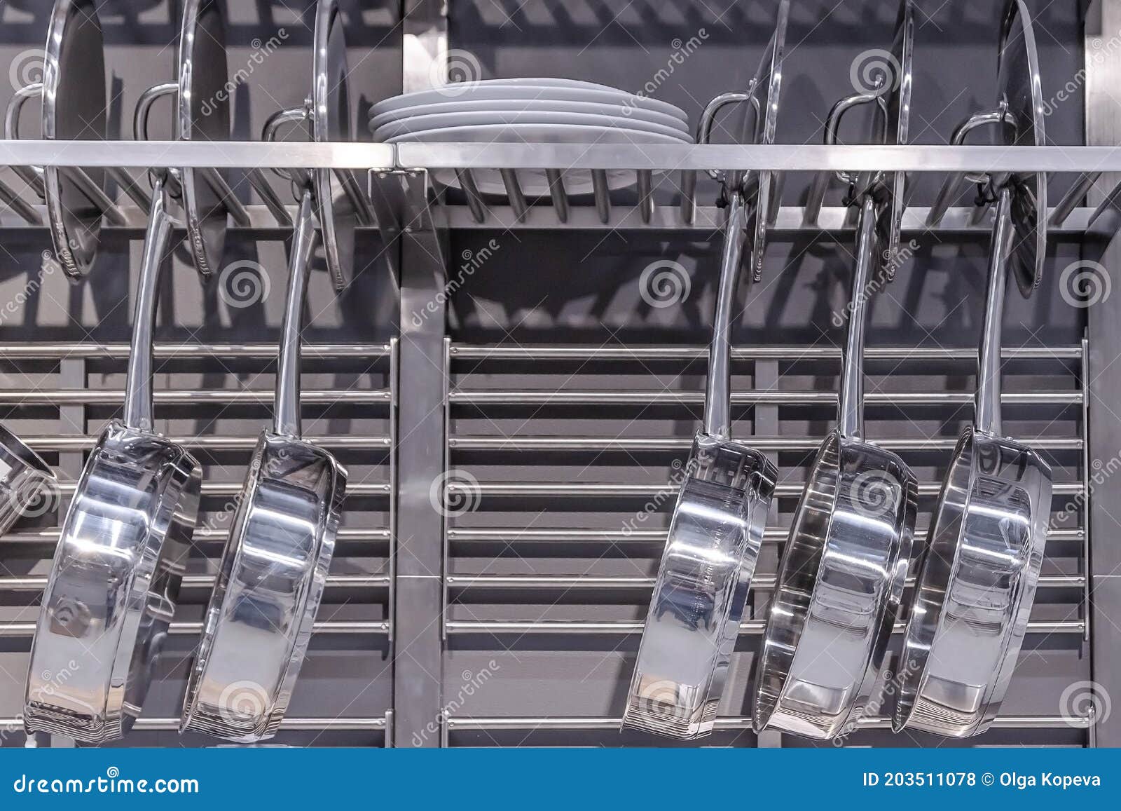 Shiny Pans Hang on a Hanger in the Kitchen Stock Photo - Image of ...