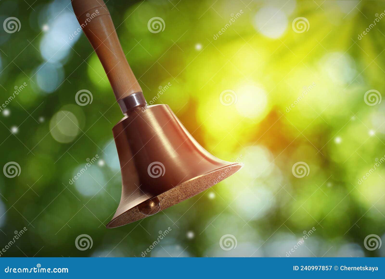 Shiny School Bell with Wooden Handle Outdoors. Bokeh Effect Stock Image ...