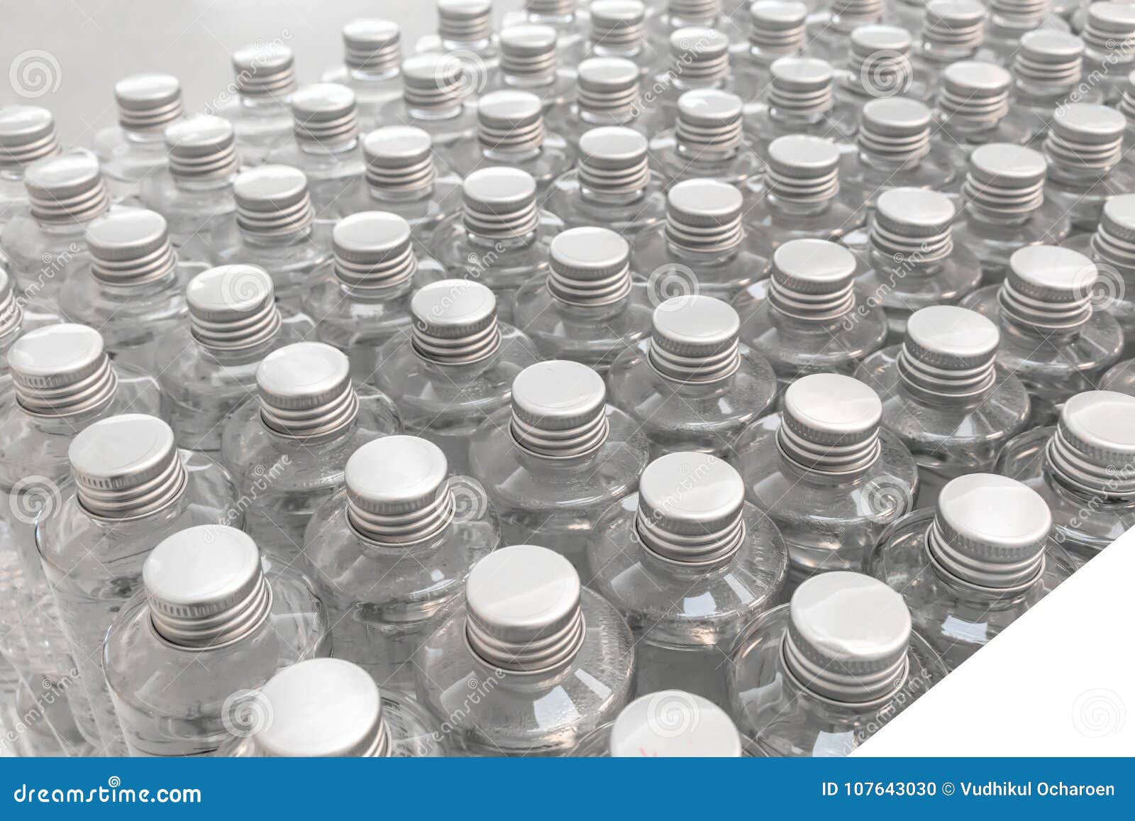 Shiny Silver Caps of Clear Plastic Bottles in Rows for Pattern B Stock ...