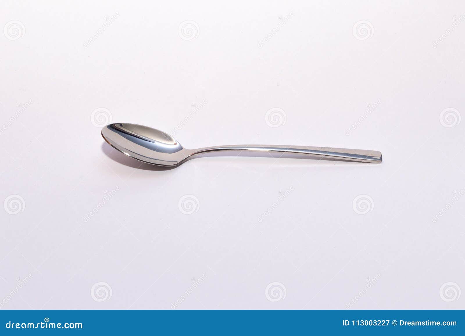 Shiny Stainless Steel Spoon on a White Solid Backround Stock Image ...